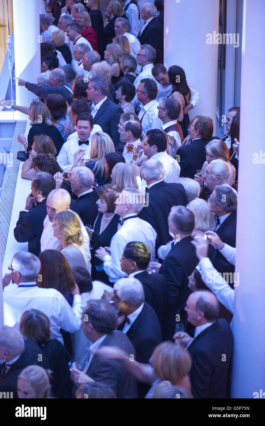 Partygoers gather on the balcony at Epsom Downs for the fireworks over ...
