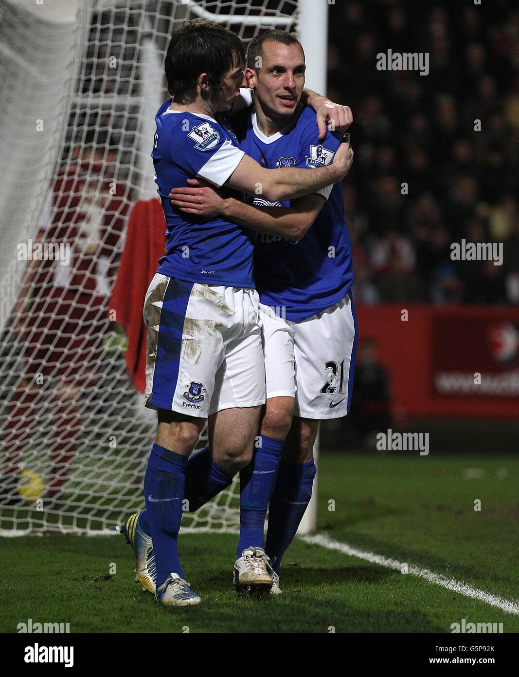 Everton's Leon Osman (no.21) celebrates scoring his side's third goal ...