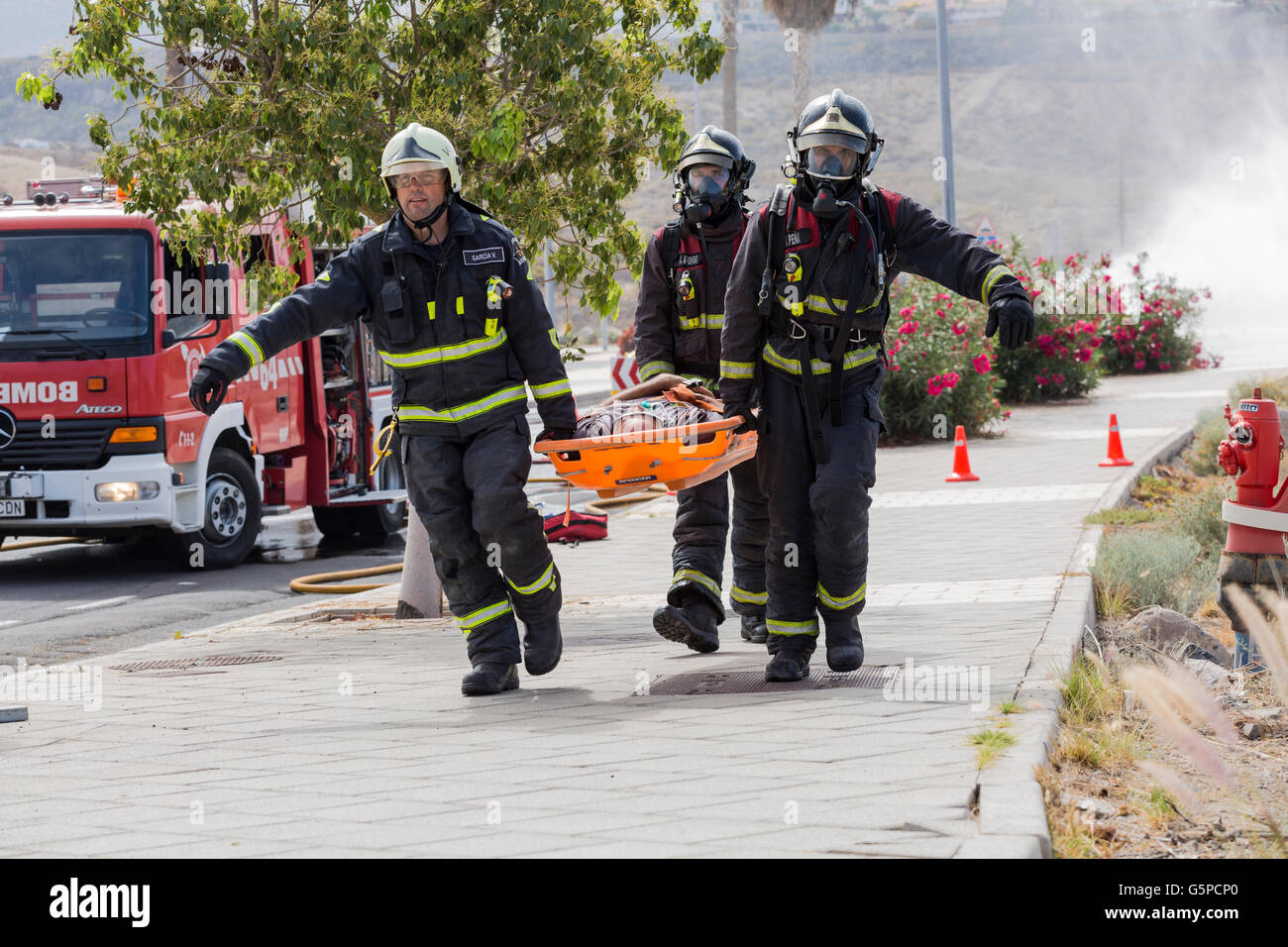 Firefighters carry victim on stretcher hi-res stock photography and ...