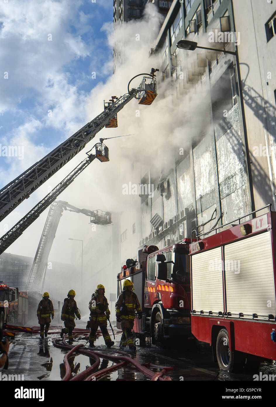 Hong Kong, China. 22nd June, 2016. Firefighters put out fire at a multi ...