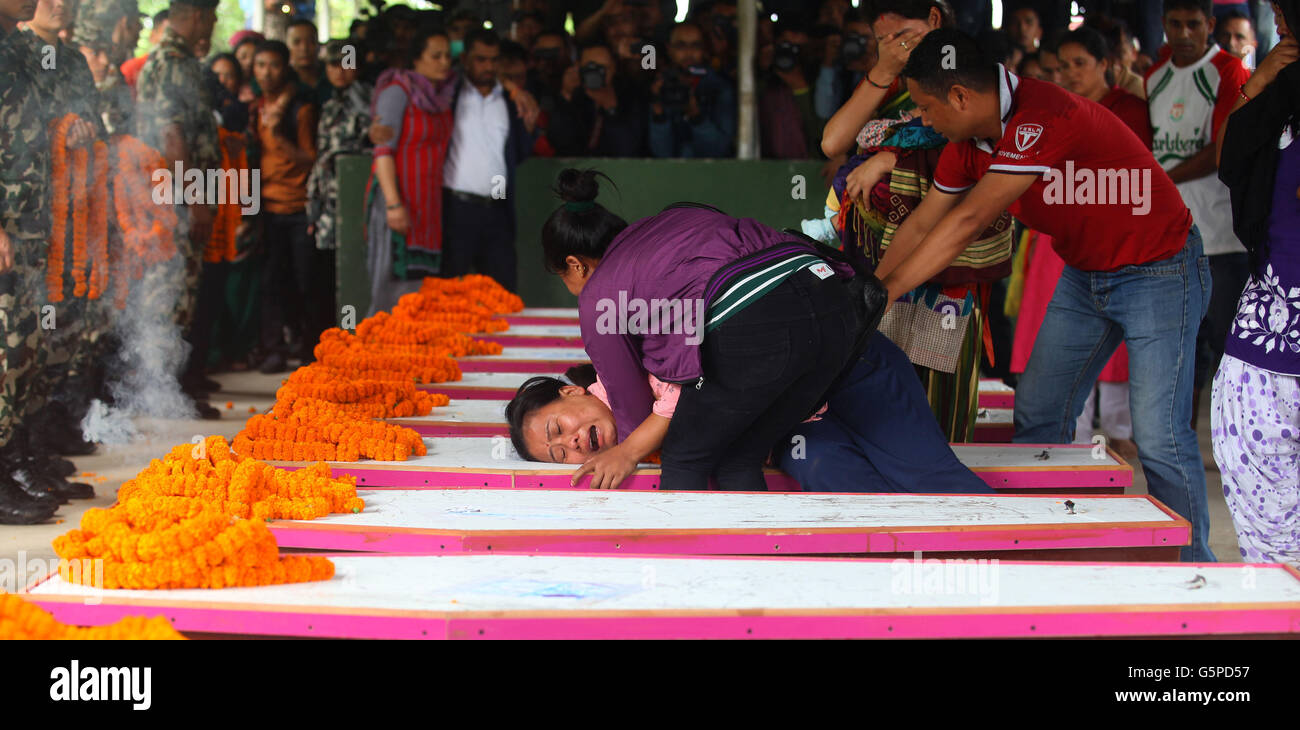 Kathmandu, Nepal. 22nd June, 2016. Wife of Jitendra Singh Thapa, cries on the coffin of her ...