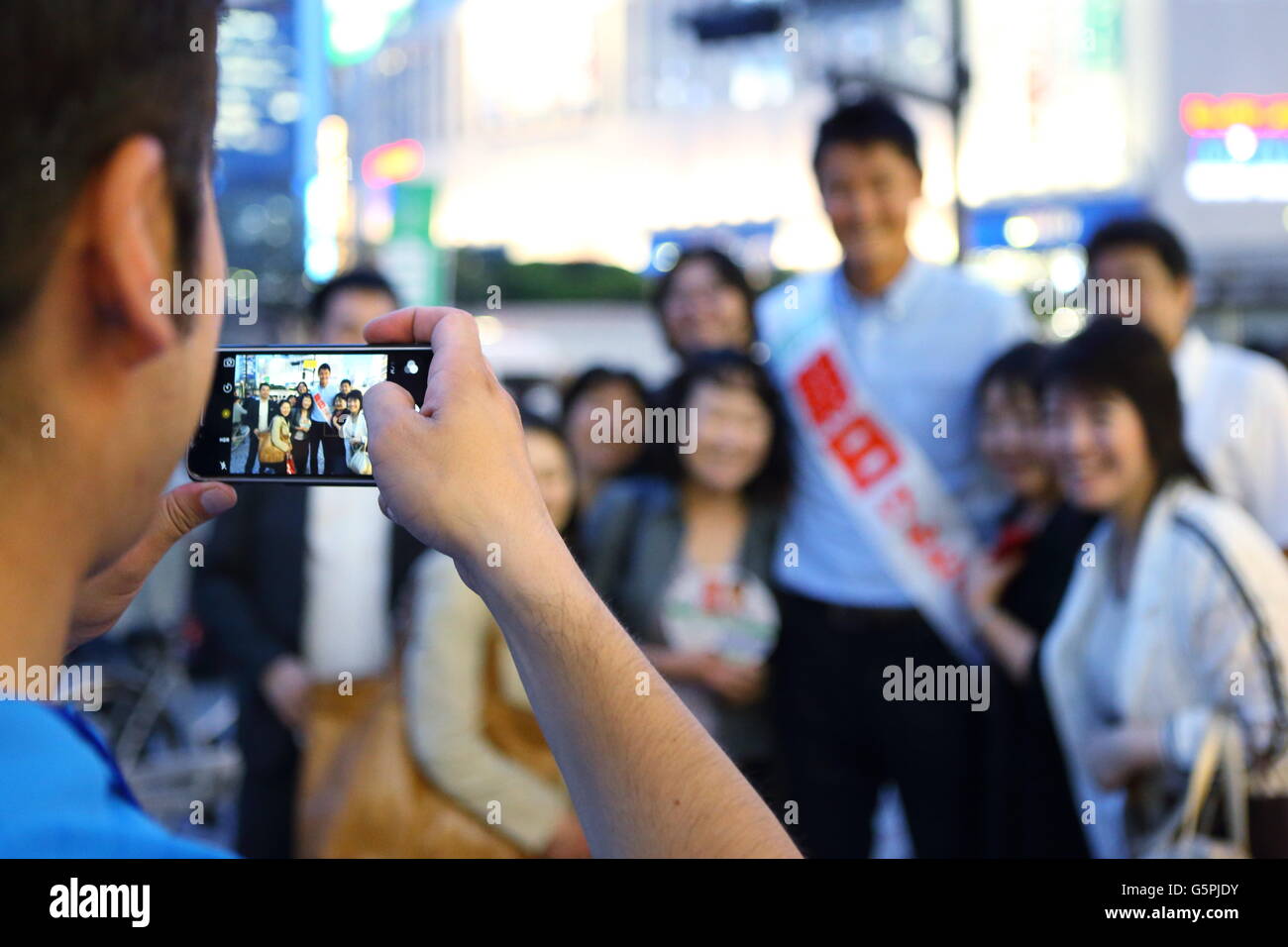 A man photographs Kentaro Asahi, former volleyball player, and ...