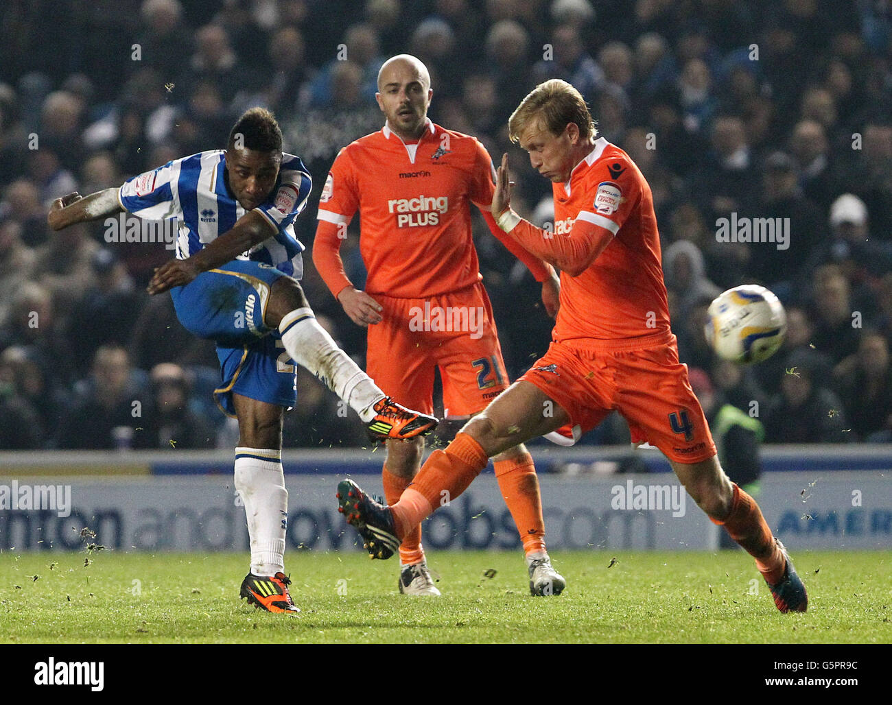 Brighton's Kazenga LuaLua (left) takes a shot at goal past Millwall's ...