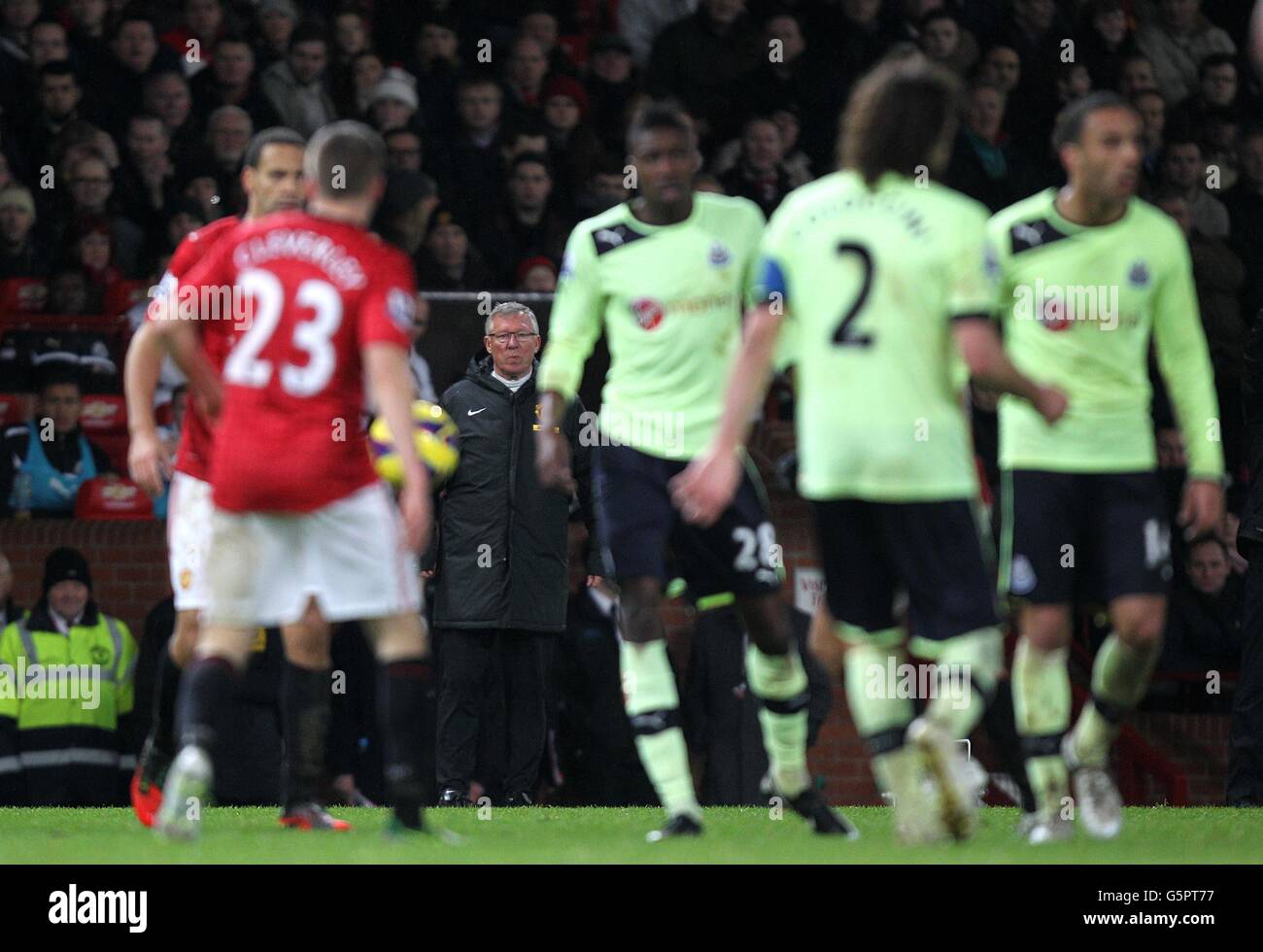 Manchester United manager Sir Alex Ferguson (centre) looks on from the ...