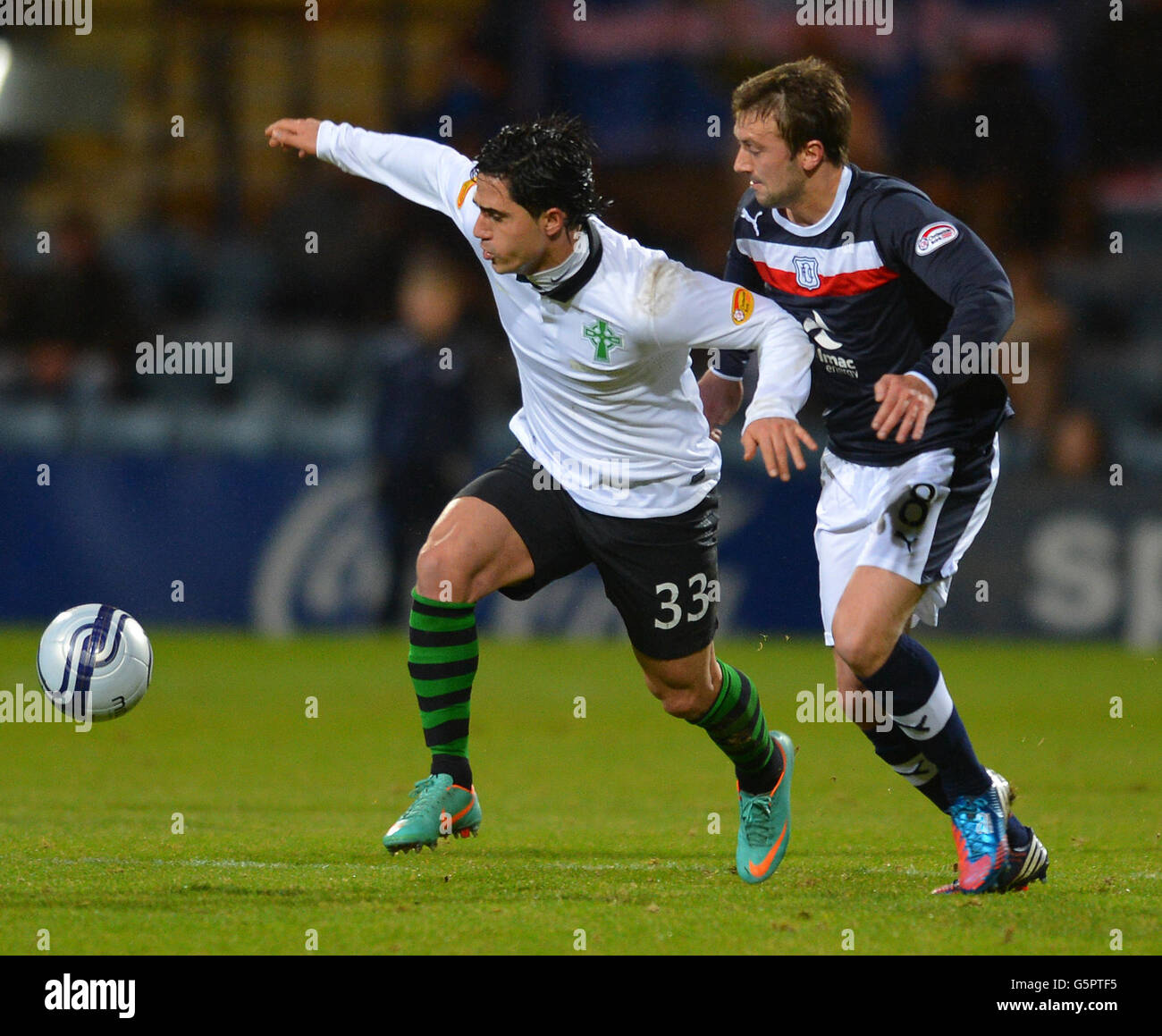 Dundee's Gary Irvine and Celtic's Beram Kayal (left) battle for the ...