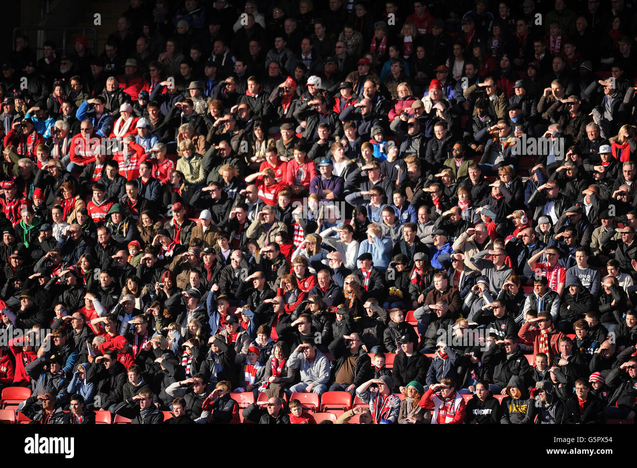 Charlton Athletic fans shield their eyes from the sun in the stands ...