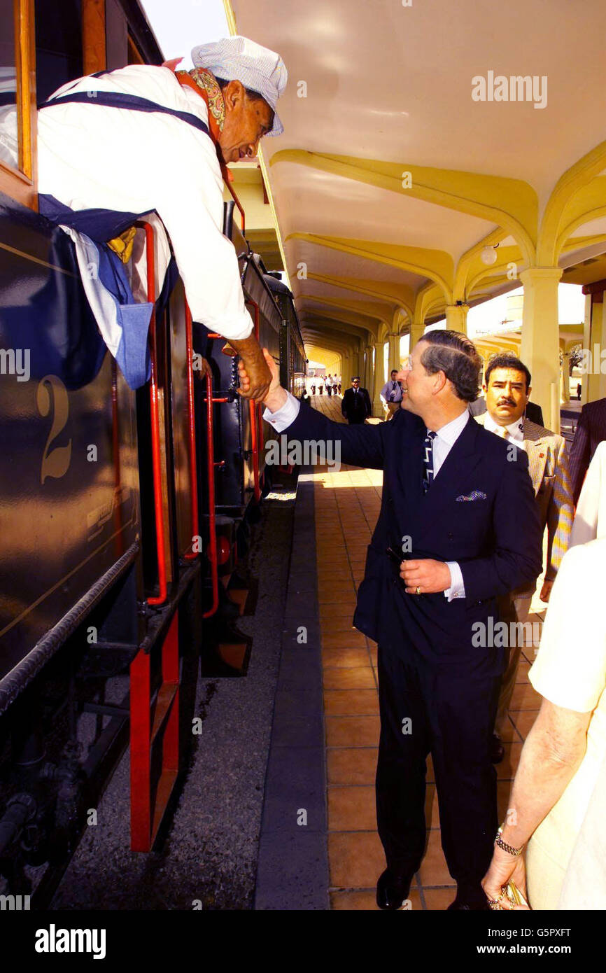 The Prince of Wales shakes hands with the driver of the steam train ...
