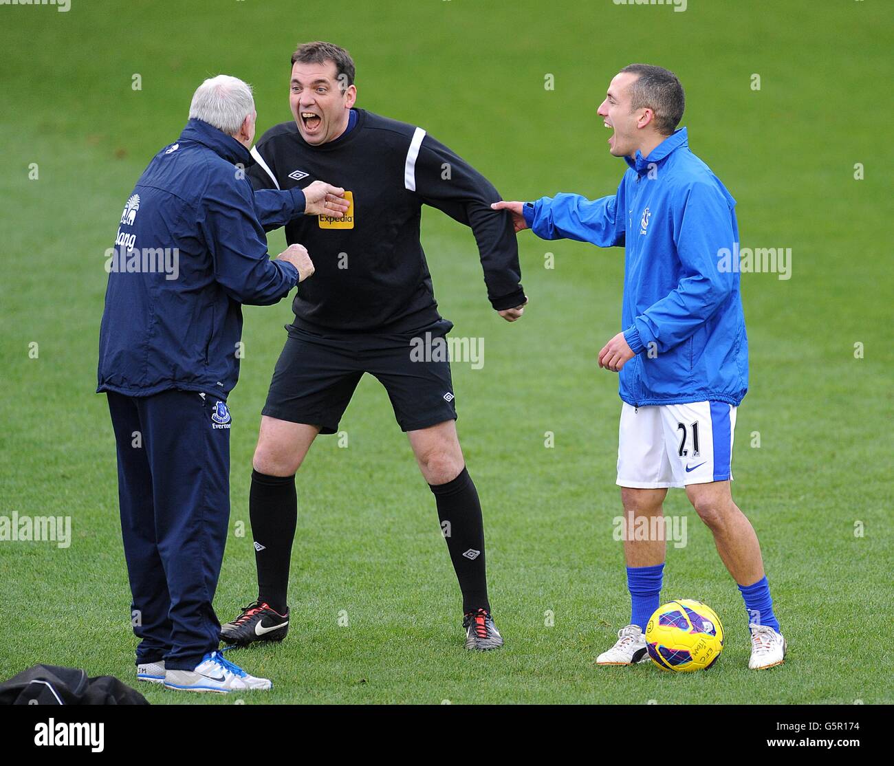 Everton's Leon Osman (right) shares a joke with referee Phil Dowd ...