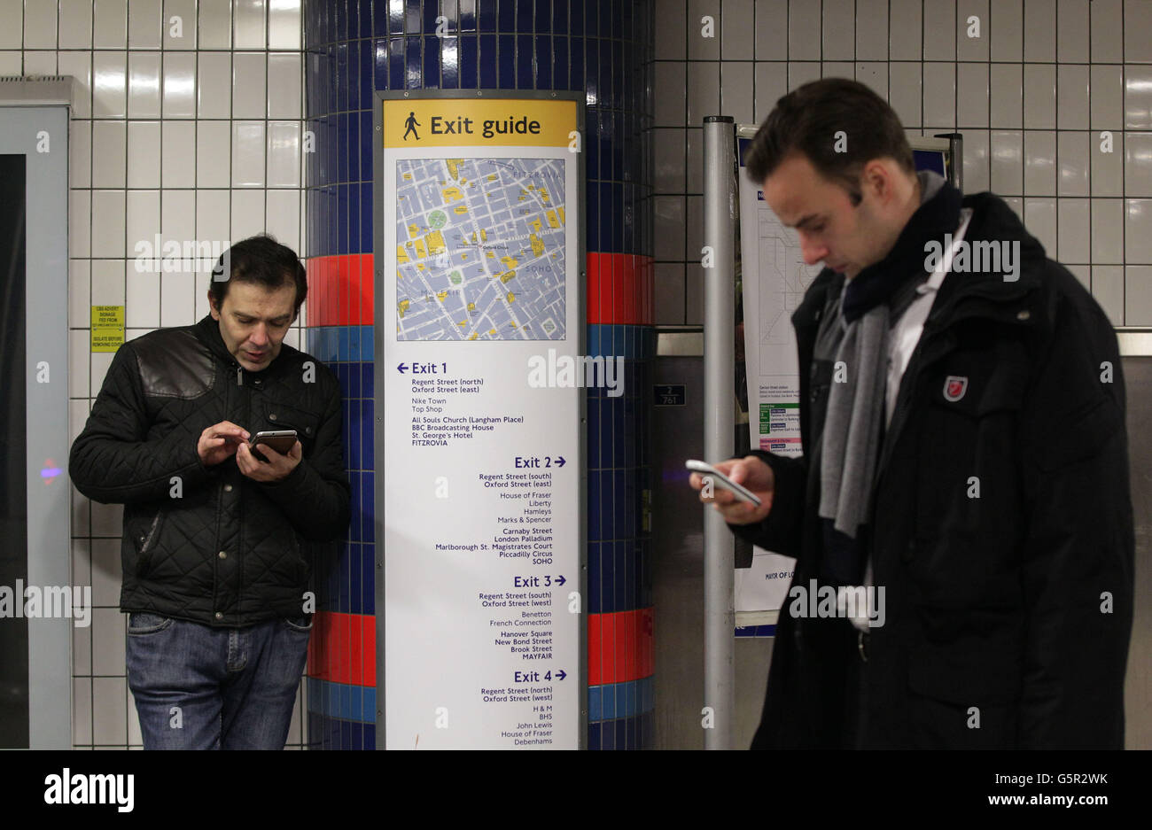 Passengers next to a sign post with directions information hi-res stock ...