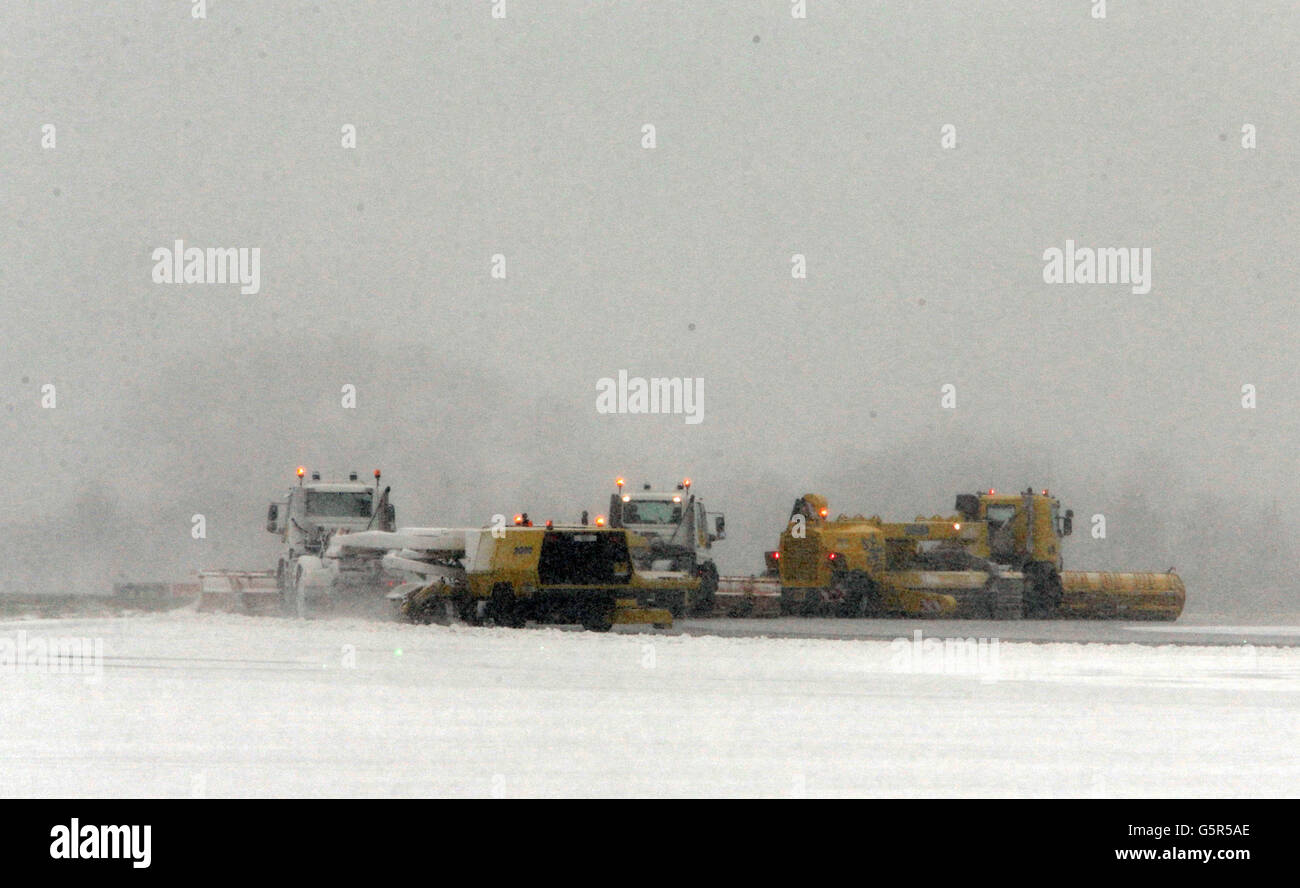 Snow ploughs clear snow from Heathrow Airport, as Britains transport ...