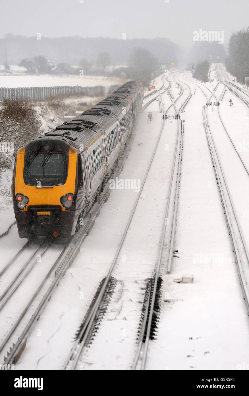 A Cross Country train makes it's way through the snow at Worting ...
