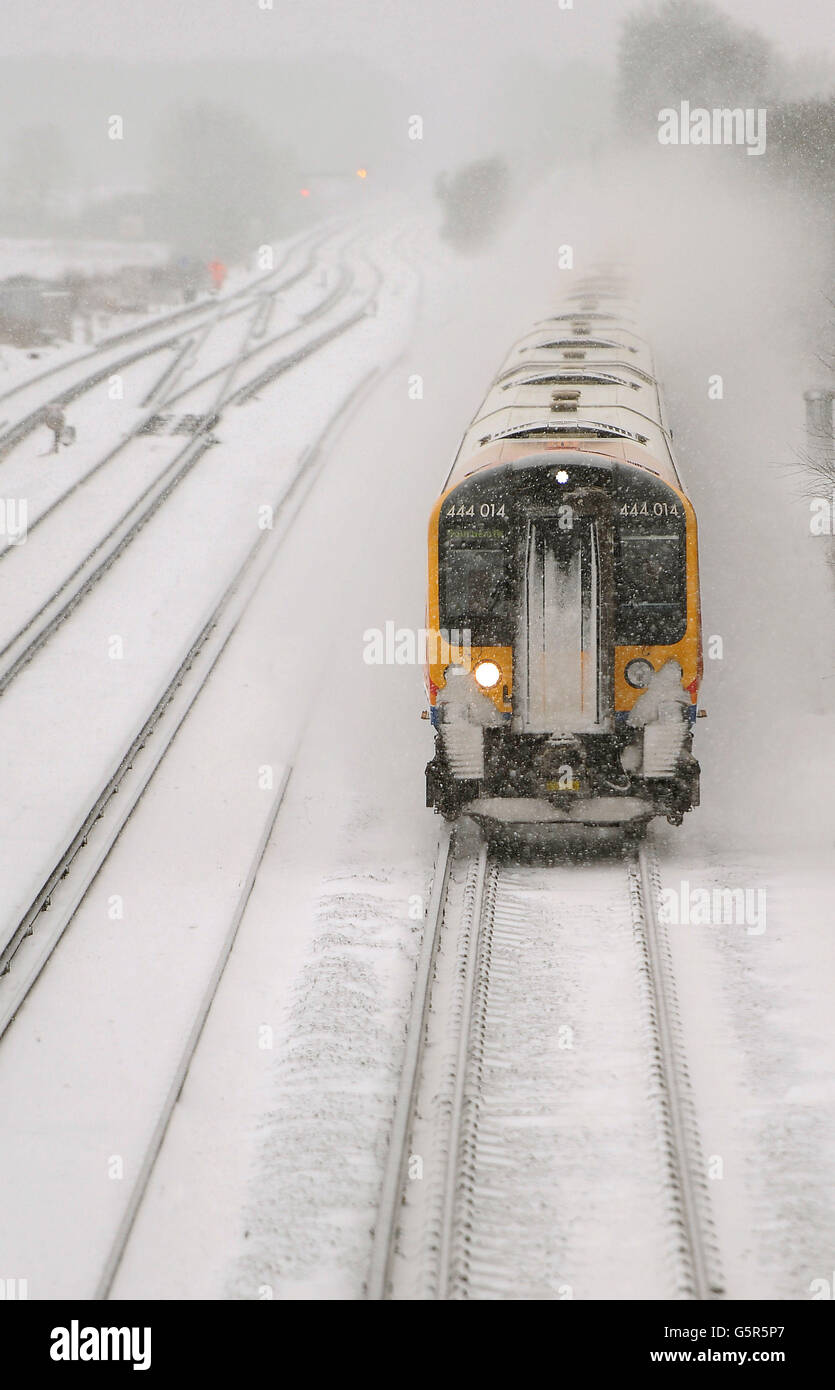 A South West Train makes it's way through the snow at Worting Junction ...