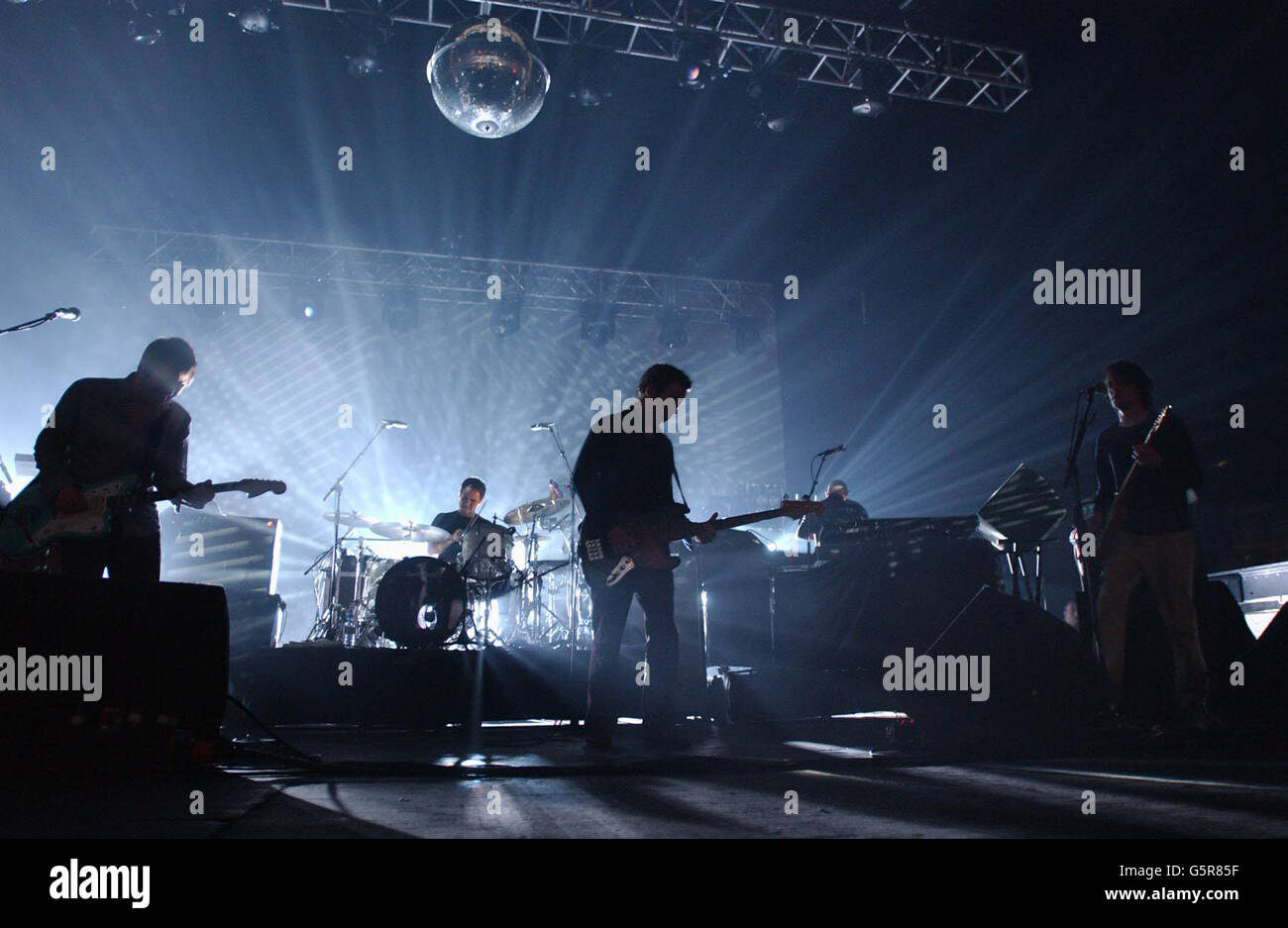 Lead singer Jason Pierce (right), performing on stage with his band ...