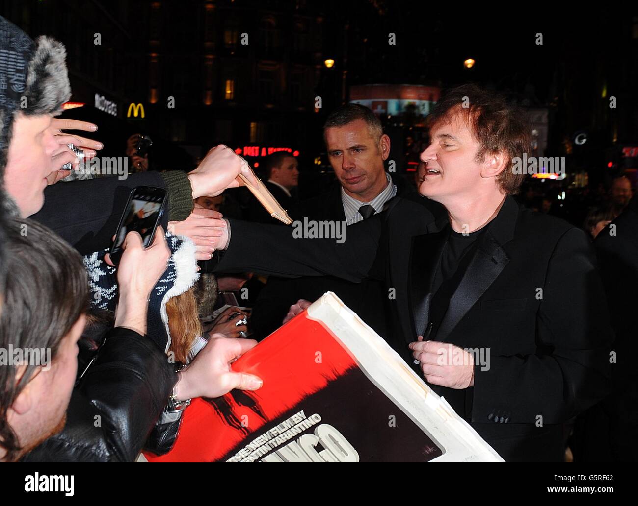 Director Quentin Tarantino signs autographs for fans as he arrives for ...