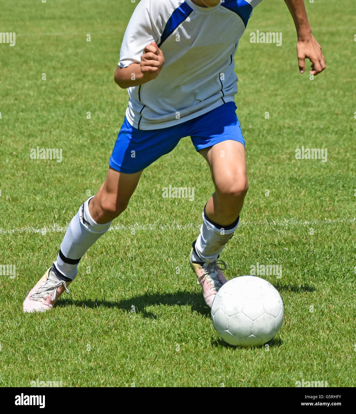 Child kicking foot ball hi-res stock photography and images - Alamy