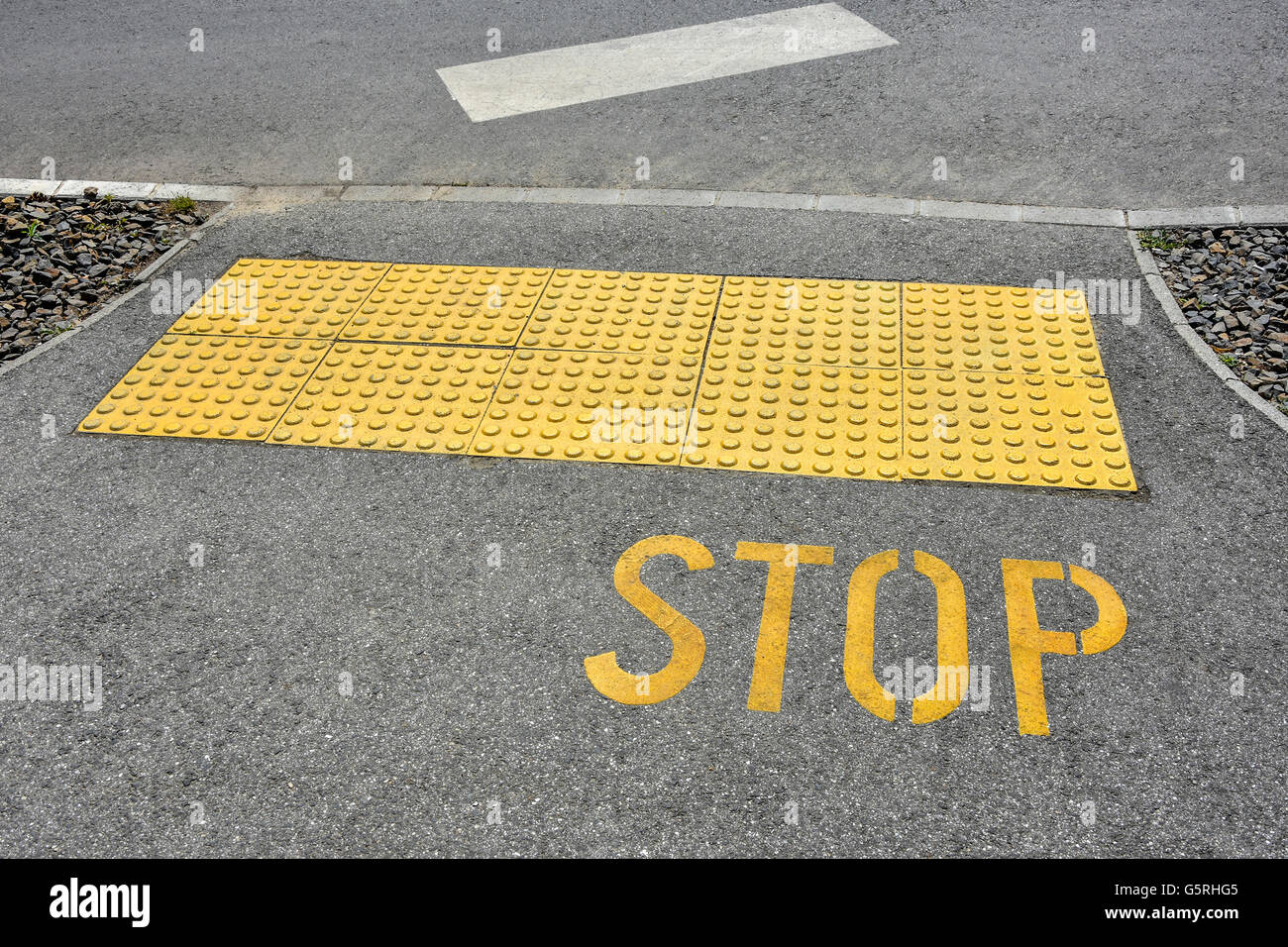 Stop sign on the asphalt at the road crossing Stock Photo - Alamy