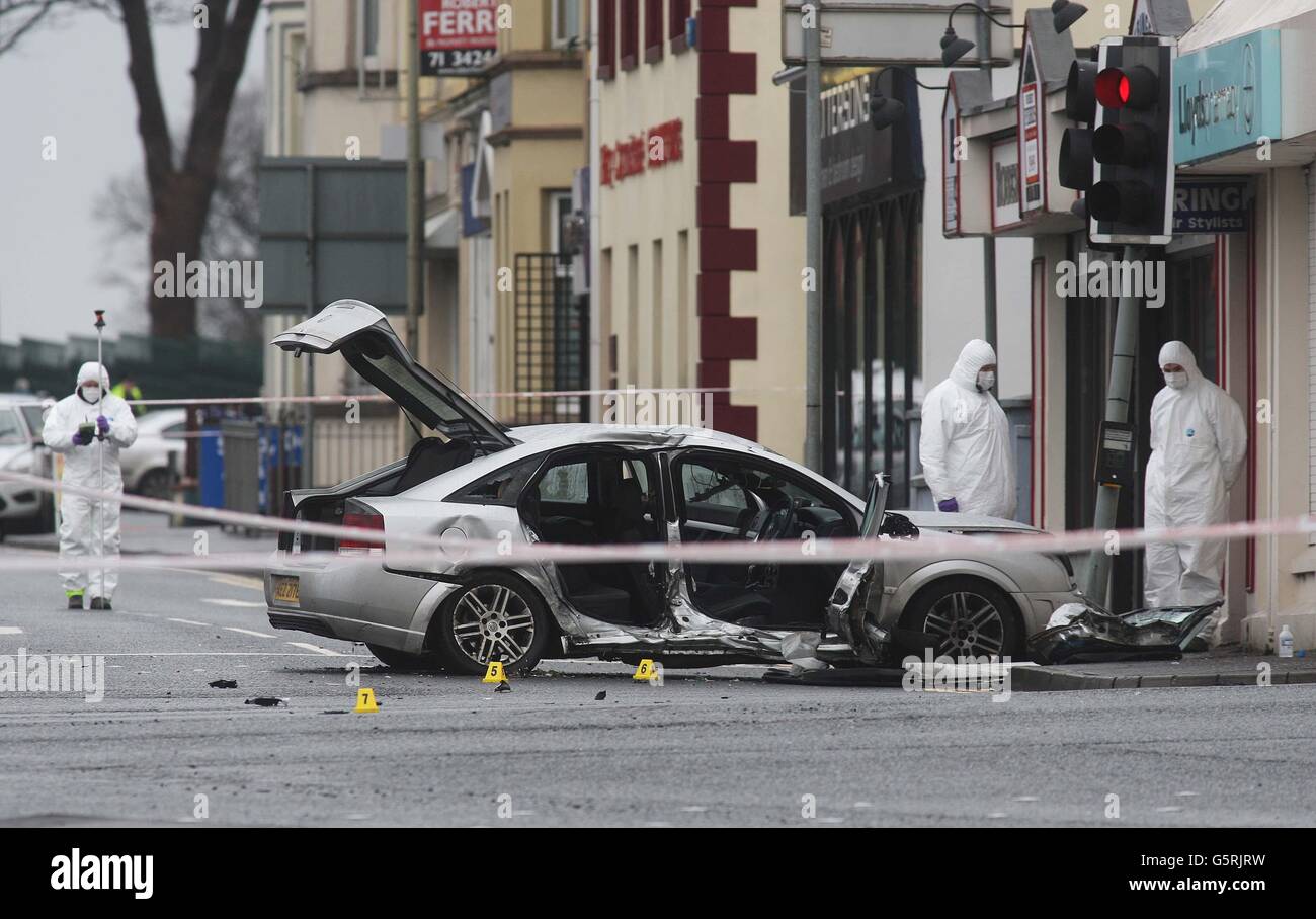 Forensic police officers at the scene of a car crash in which a ...