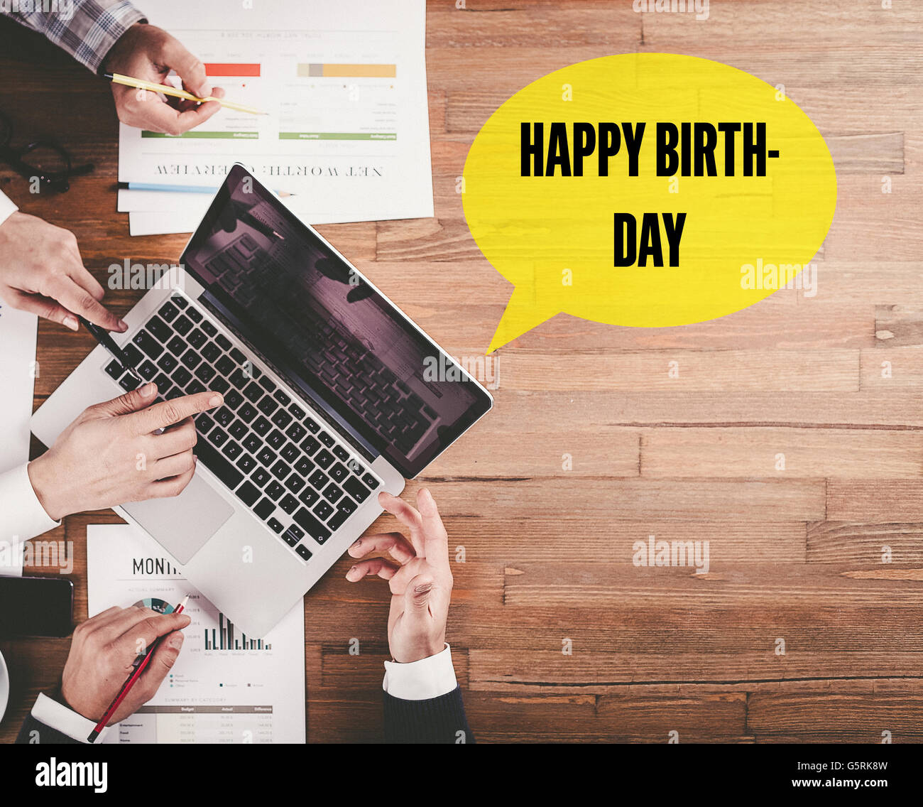 BUSINESS TEAM WORKING IN OFFICE WITH HAPPY BIRTHDAY SPEECH BUBBLE ON ...