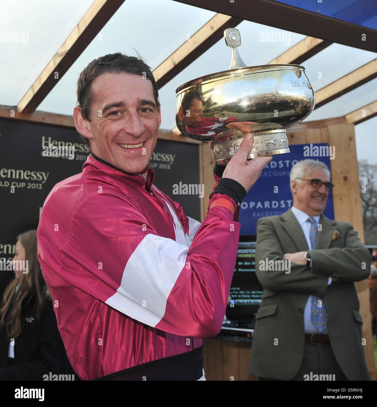 Jockey Davy Russell holds the Hennessy Gold Cup after he rode Sir Des ...