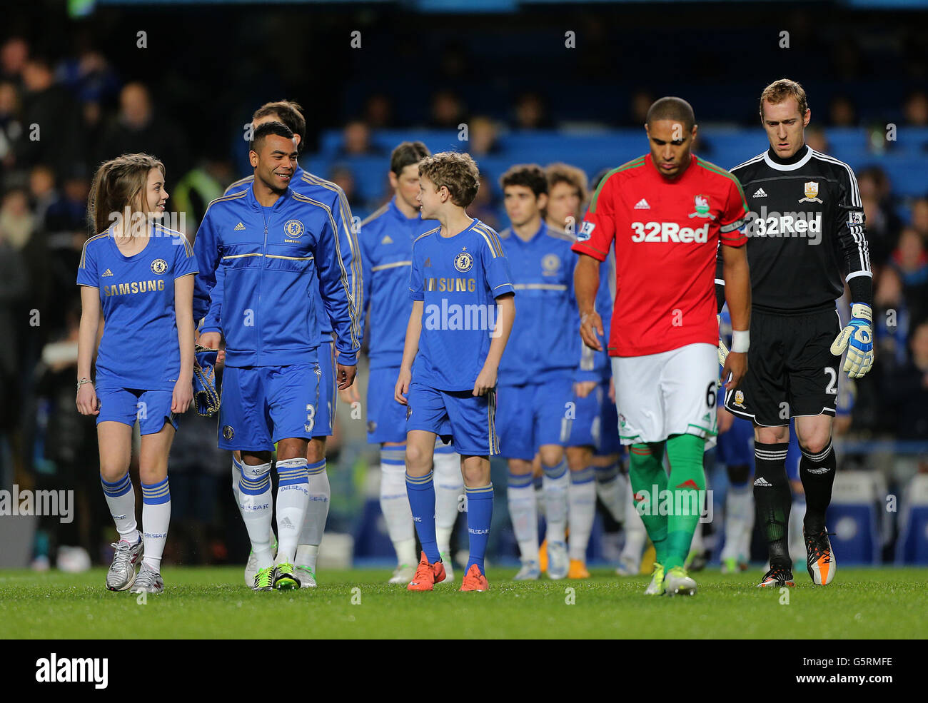 Chelsea captain Ashley Cole (left) leads his players onto the pitch ...