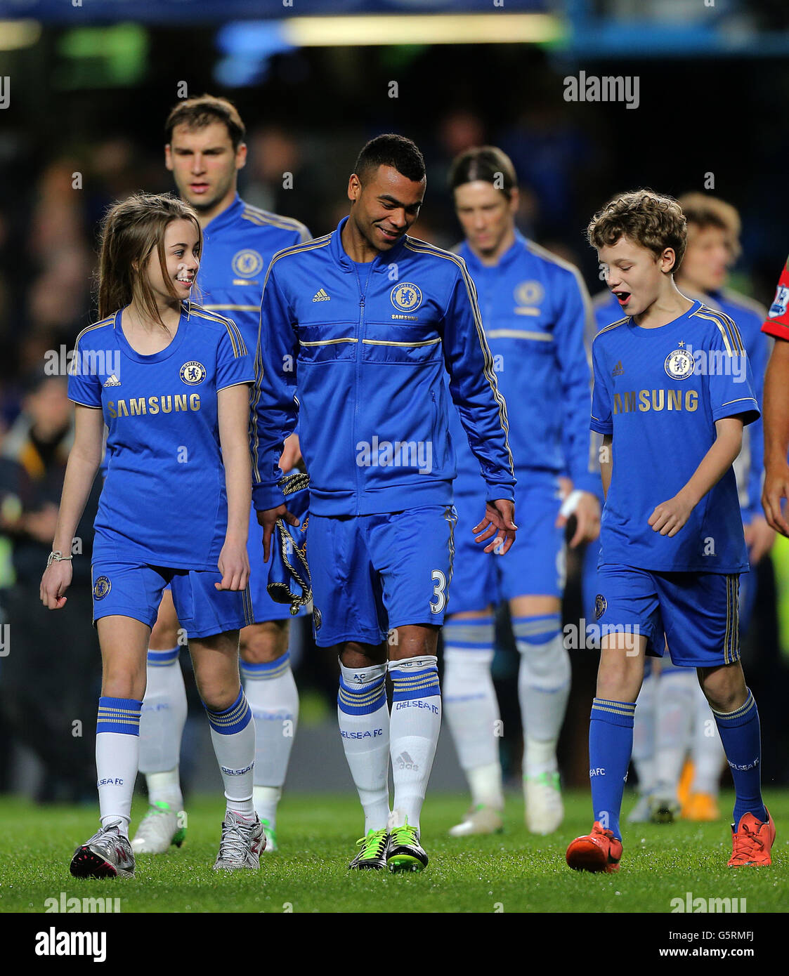 Chelsea's Ashley Cole walks out with the mascots before the game Stock ...