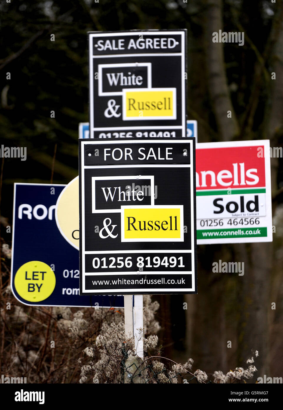 General view of Sale Agreed, For Sale, Let By and Sold signs outside an ...