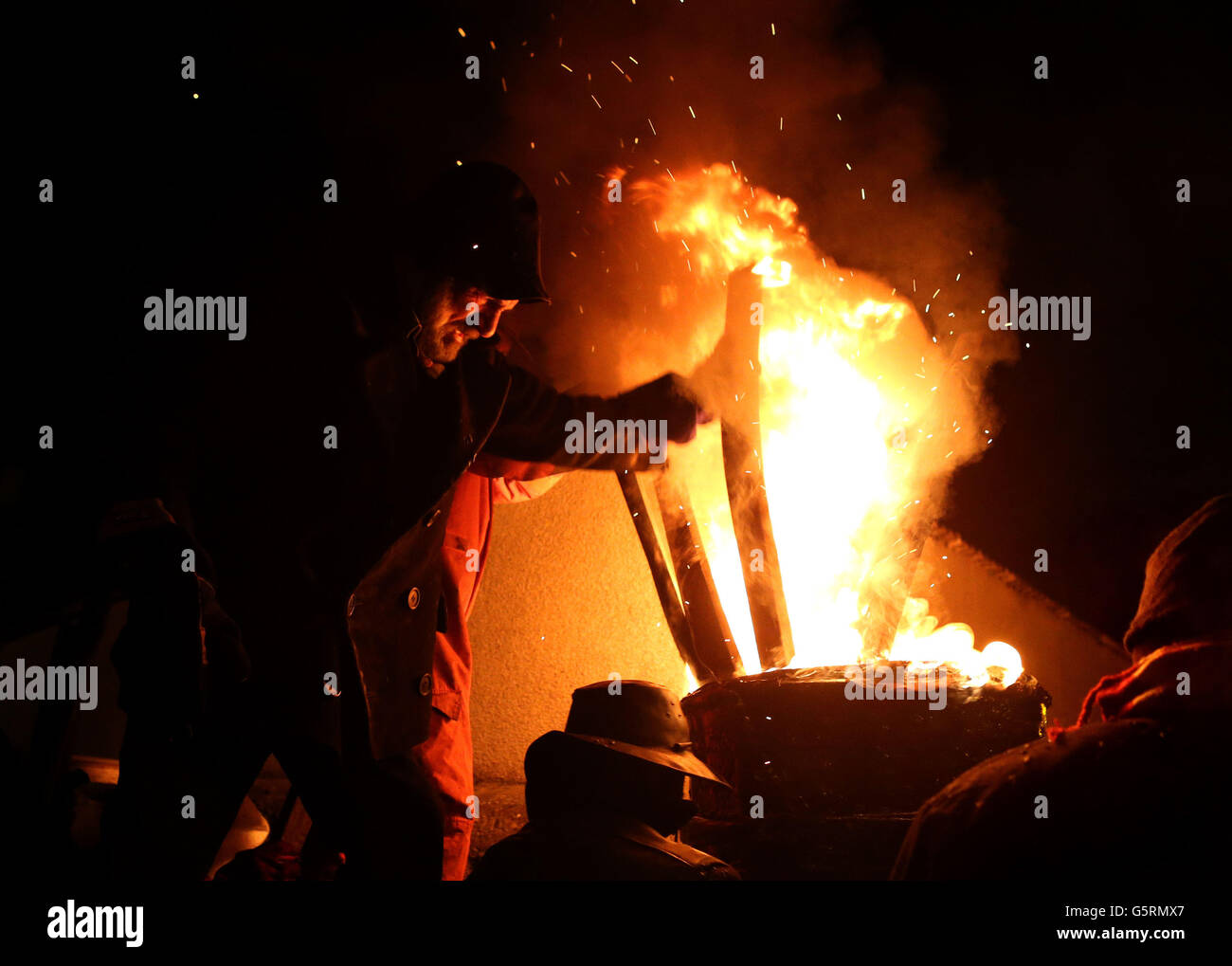 A member of the Clavie crew loads the Clavie as the Clavie King and his ...