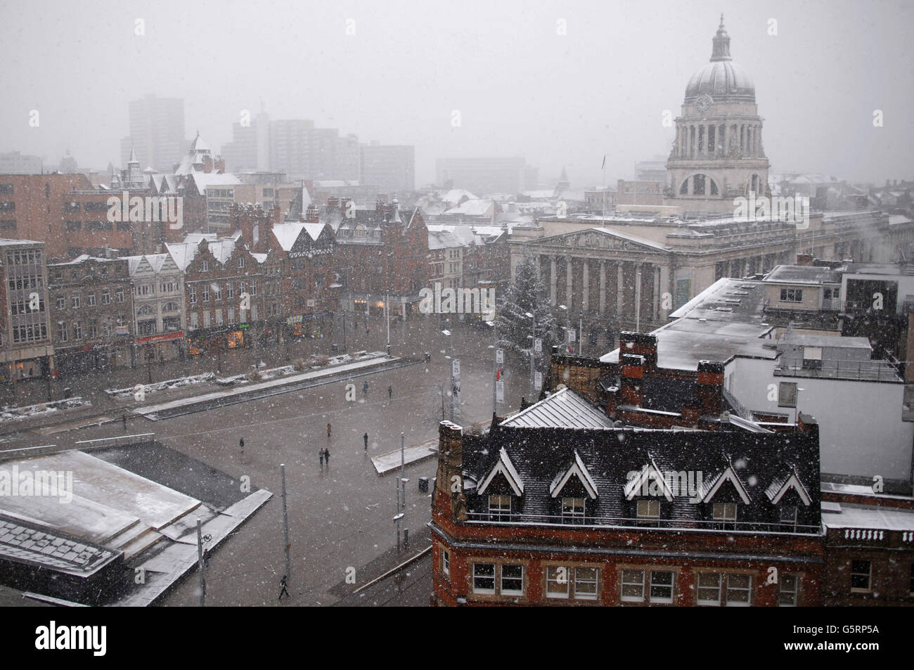 A general view as snow falls over the Old Market Square in Nottingham ...