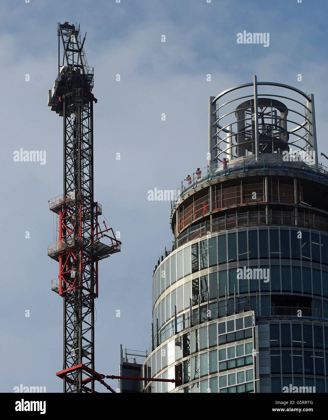 Construction workers view the damaged crane on top of St Georges Tower ...