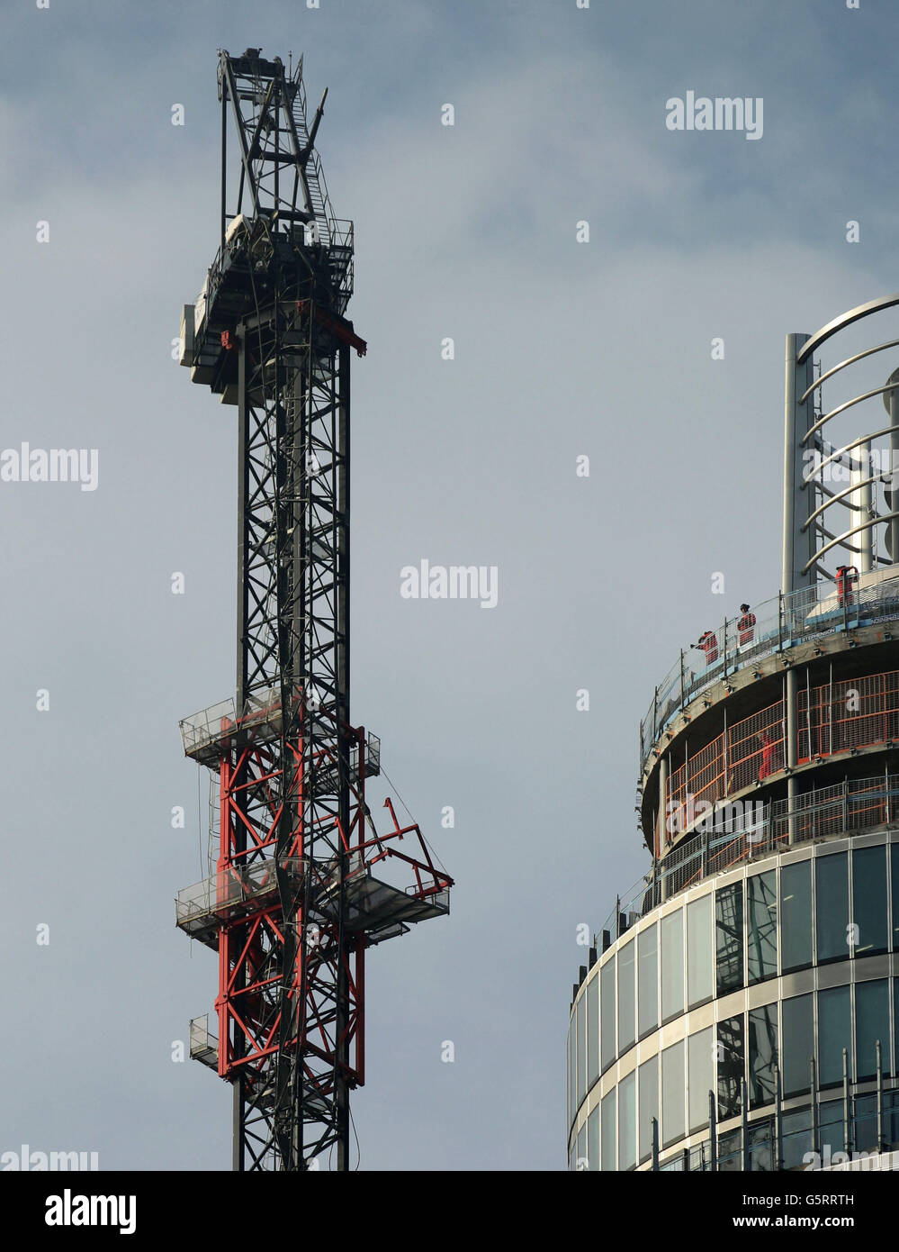 Construction workers view the damaged crane on top of St Georges Tower ...