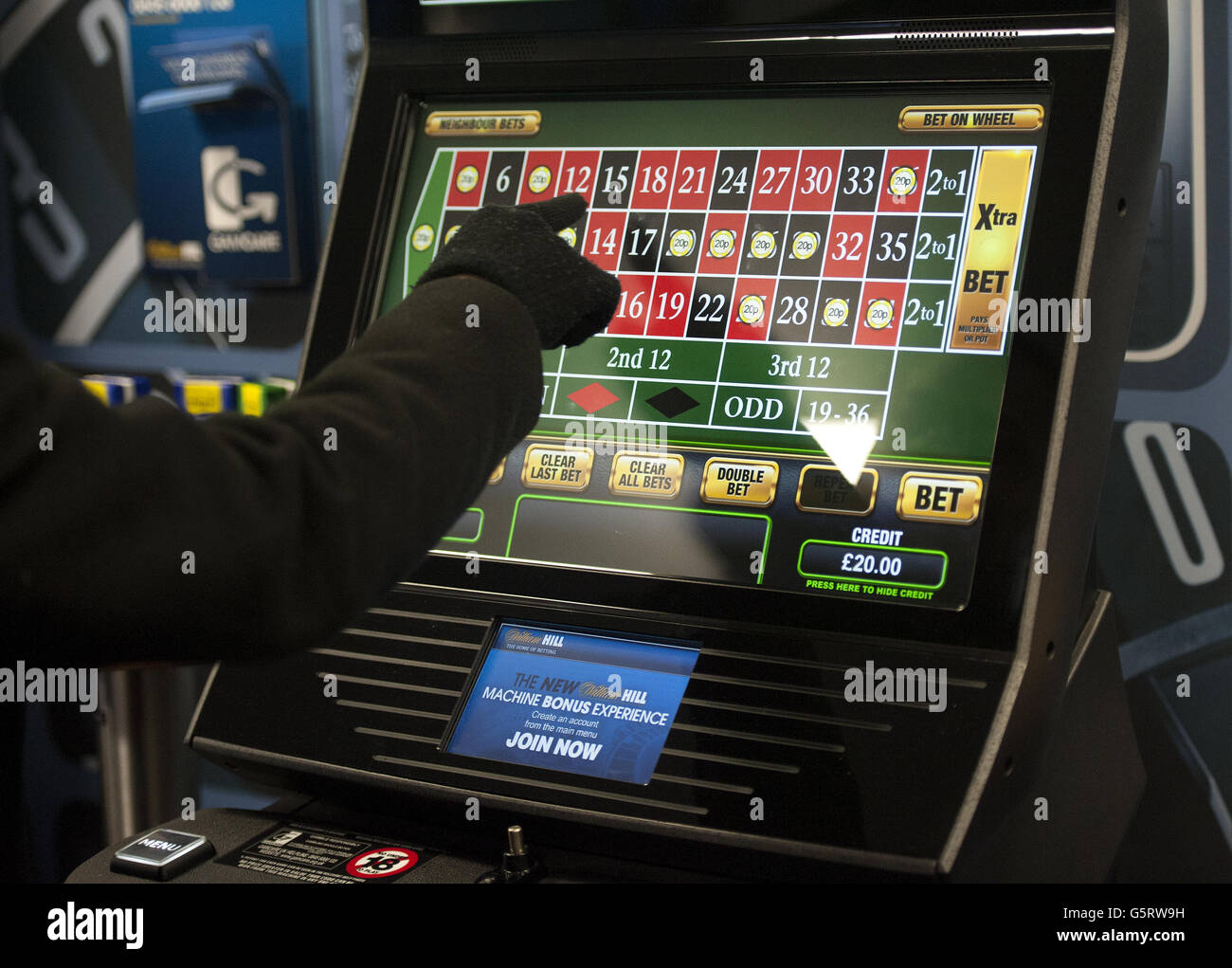 A punter tries out a new gambling machine during the opening of new ...