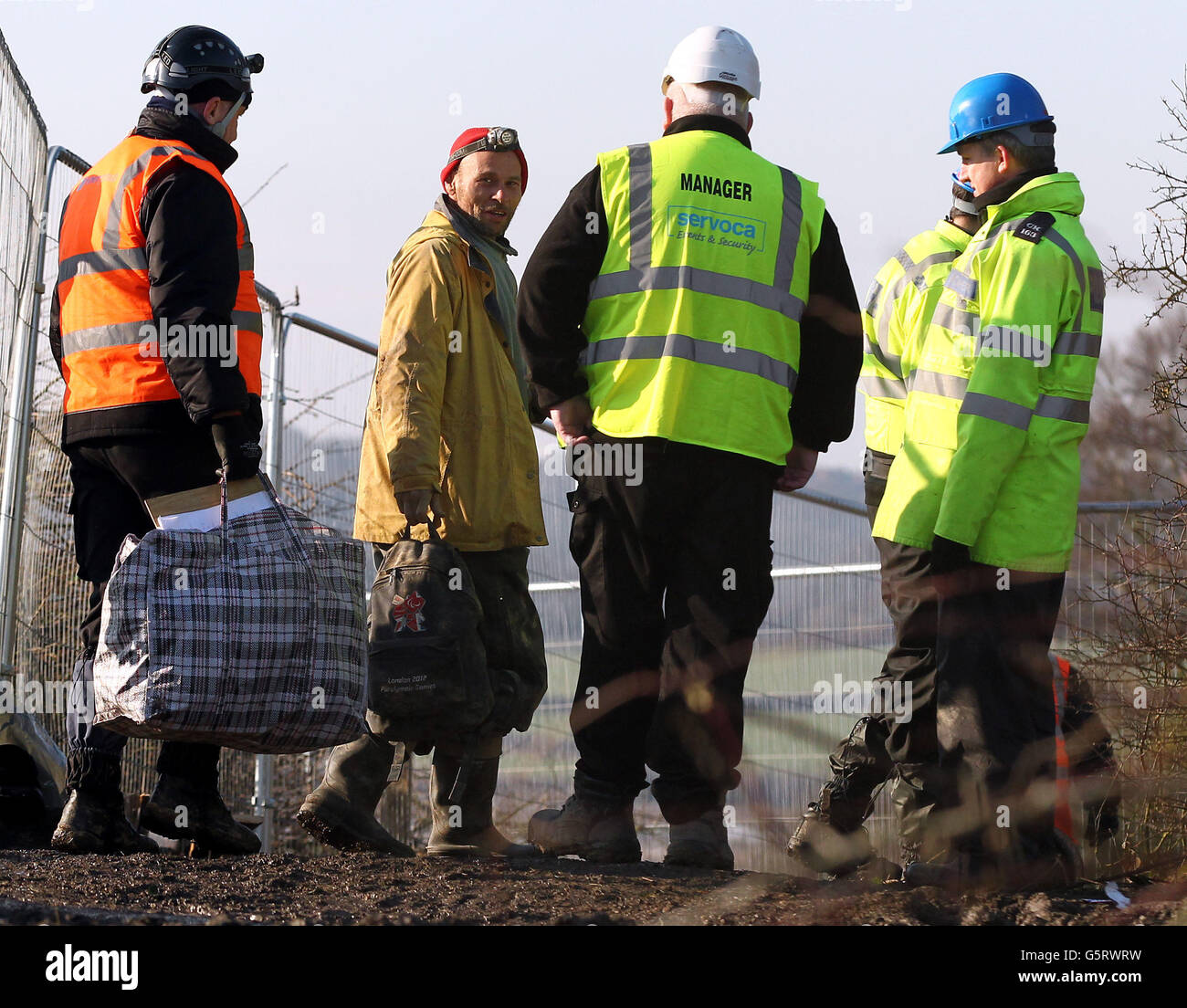 A road protestor known as Simon Sitting Bull (second from left) is led ...