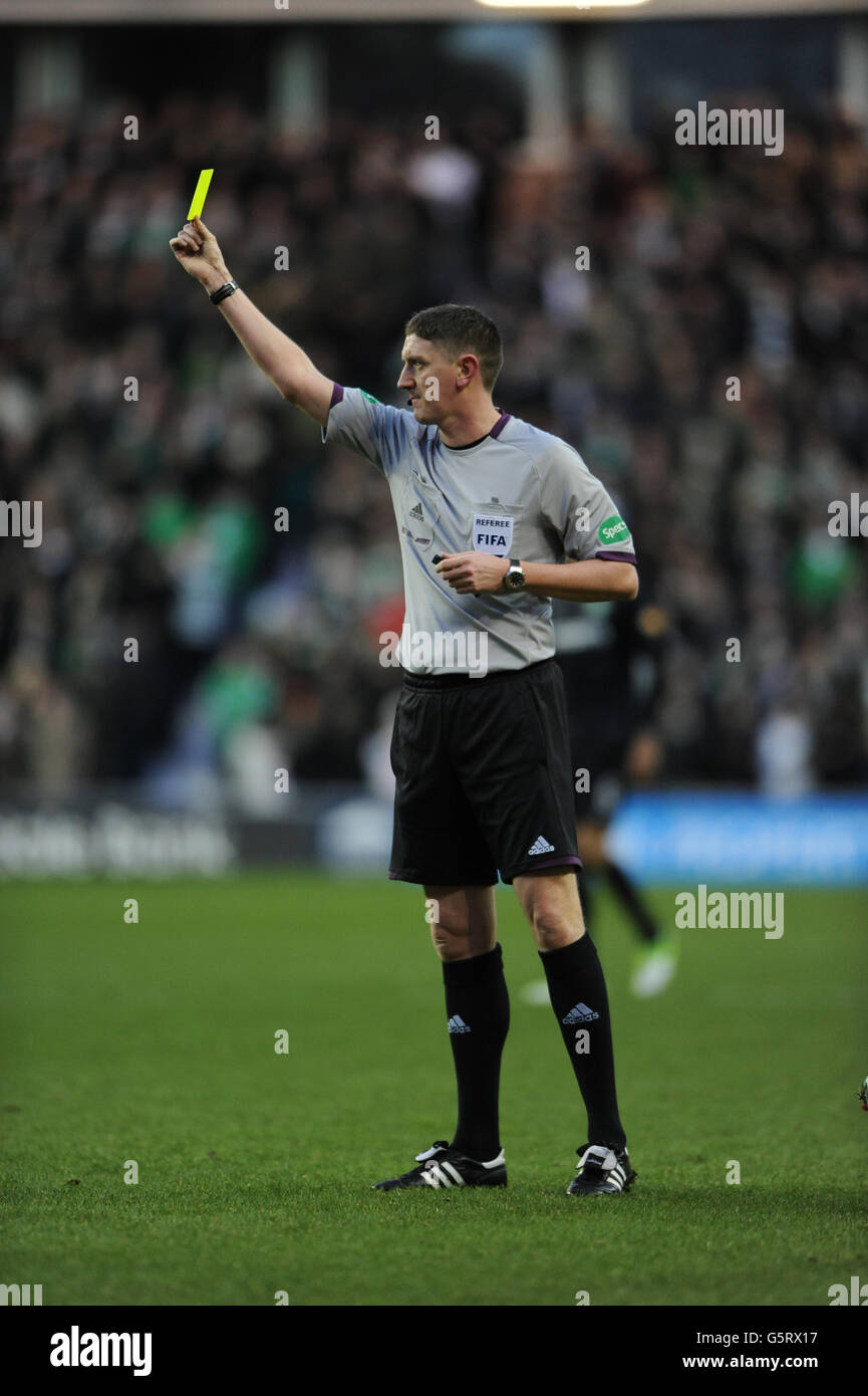 Referee craig thomson shows a yellow card hi-res stock photography and ...
