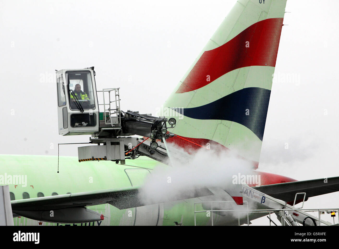 A British Airways plane is de-iced at Heathrow Airport Stock Photo - Alamy