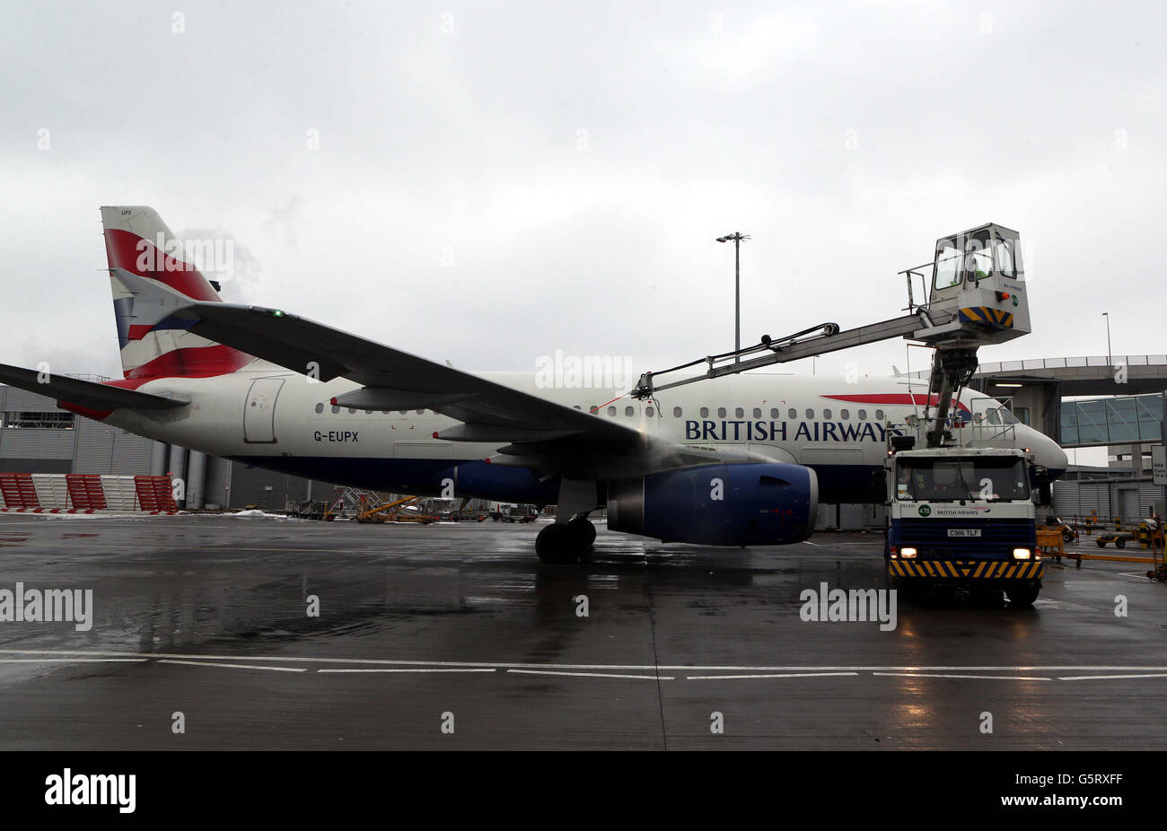 A British Airways plane is de-iced at Heathrow Airport Stock Photo - Alamy