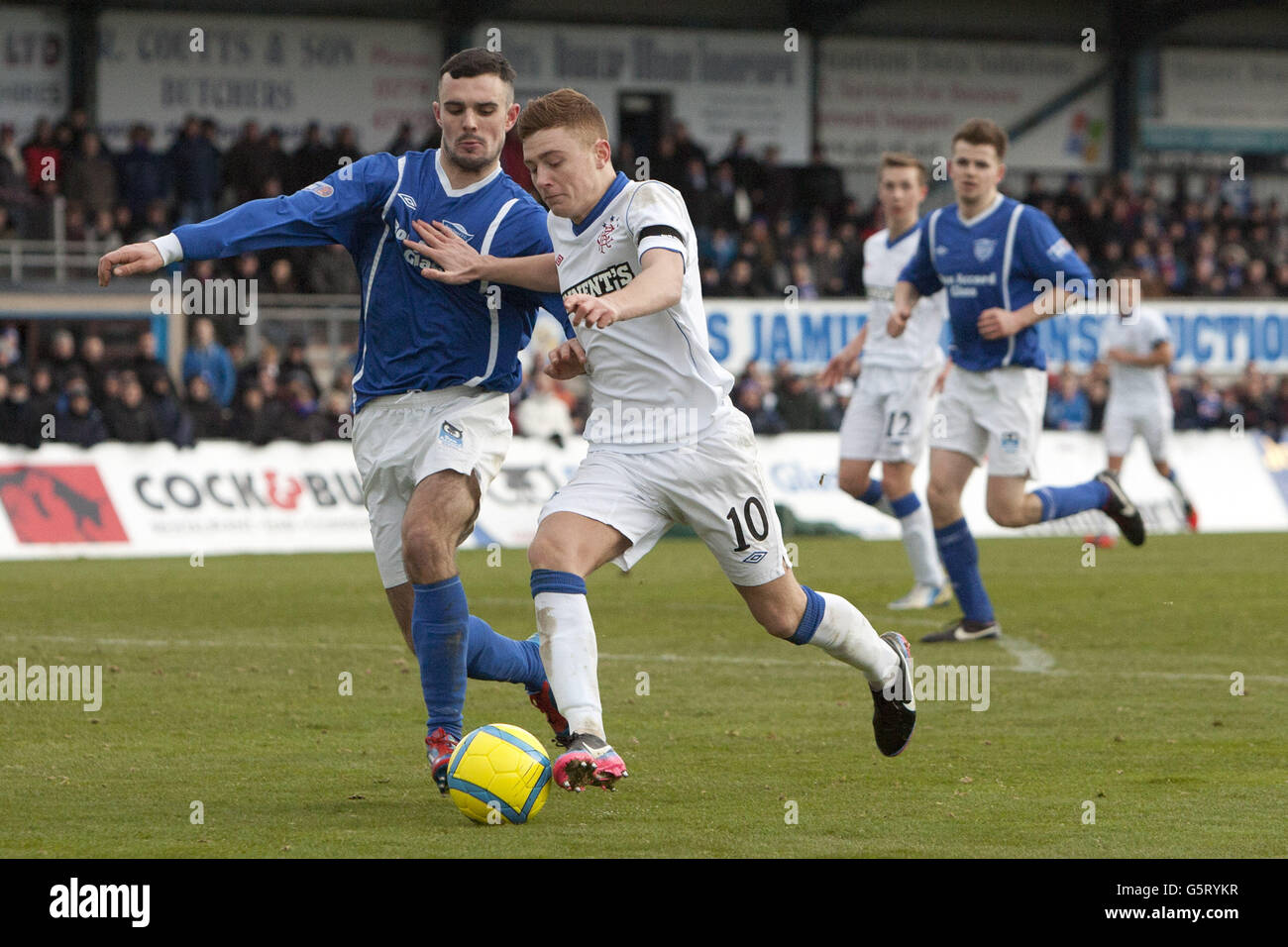 Rangers' Lewis Macleod holds off Peterhead's Martin Bavidge (left ...