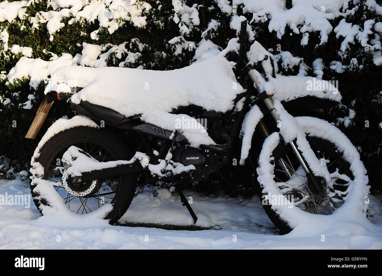 A motorbike covered in snow at Newhall, Derbyshire as the winter ...