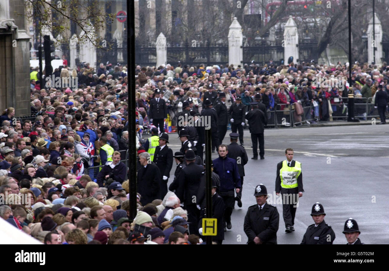 Crowds wait for the procession carrying the coffin of Queen Elizabeth ...