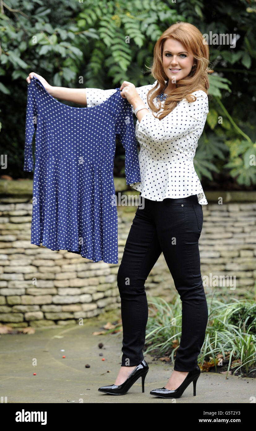 Liz Evans, 27, from Liverpool, holds up at item of clothing that she ...