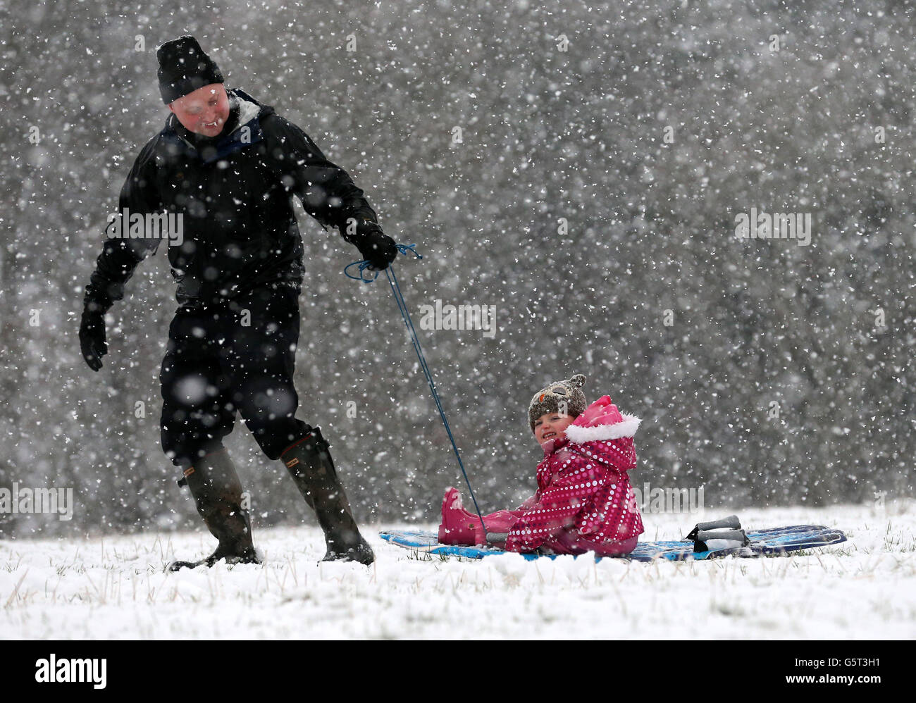 Davie Booth and three year-old daughter Freya sledging in Doune ...