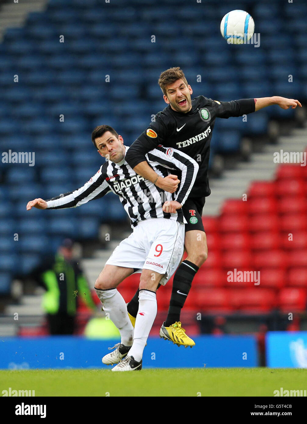 St Mirren's Steven Thompson and Celtic's Charlie Mulgrew (right) jump ...