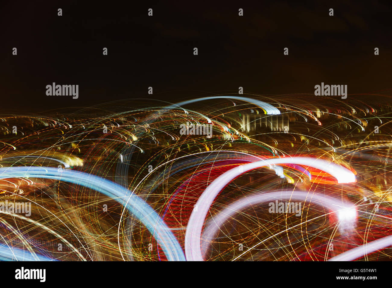 Abstract moving light trails in a city at night Stock Photo - Alamy