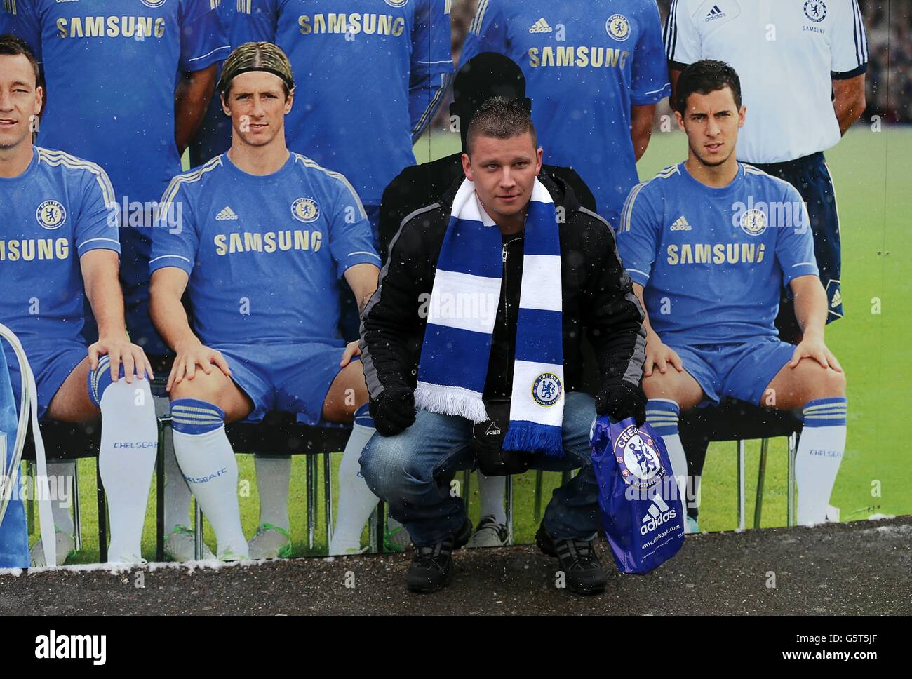 Fans pose for photographs in front of the team group picture on the ...