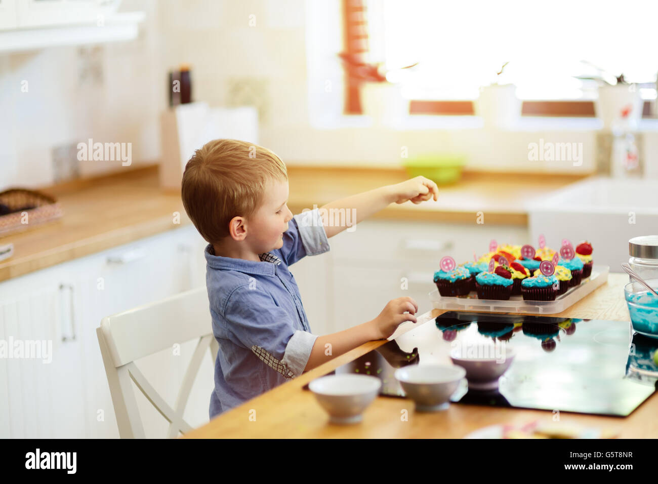 Cute child tasting cookies in kitchen Stock Photo - Alamy