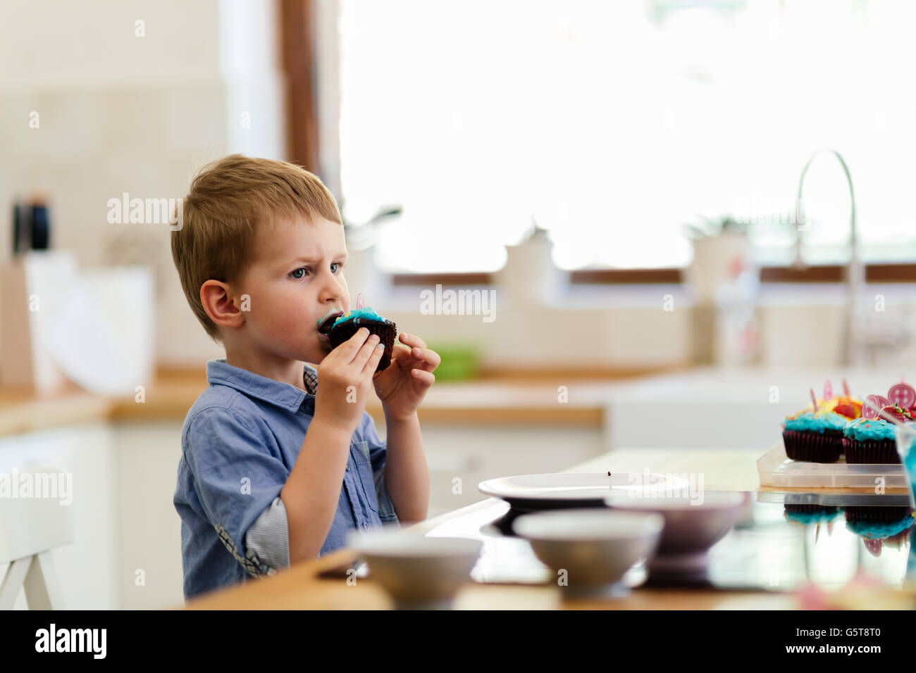 Cute child tasting cookies in kitchen Stock Photo - Alamy