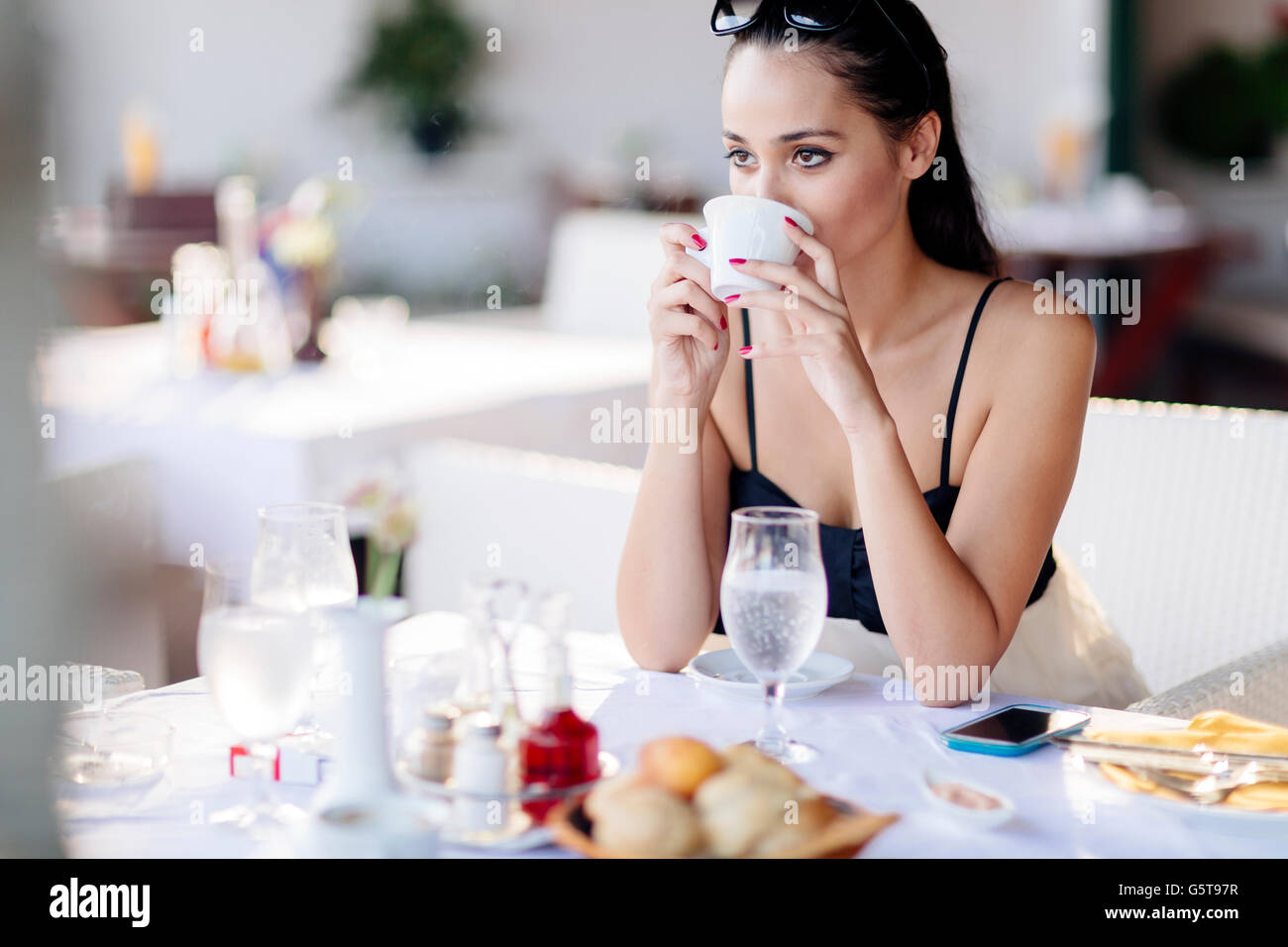 Beautiful young women drinking tea in restaurant Stock Photo - Alamy