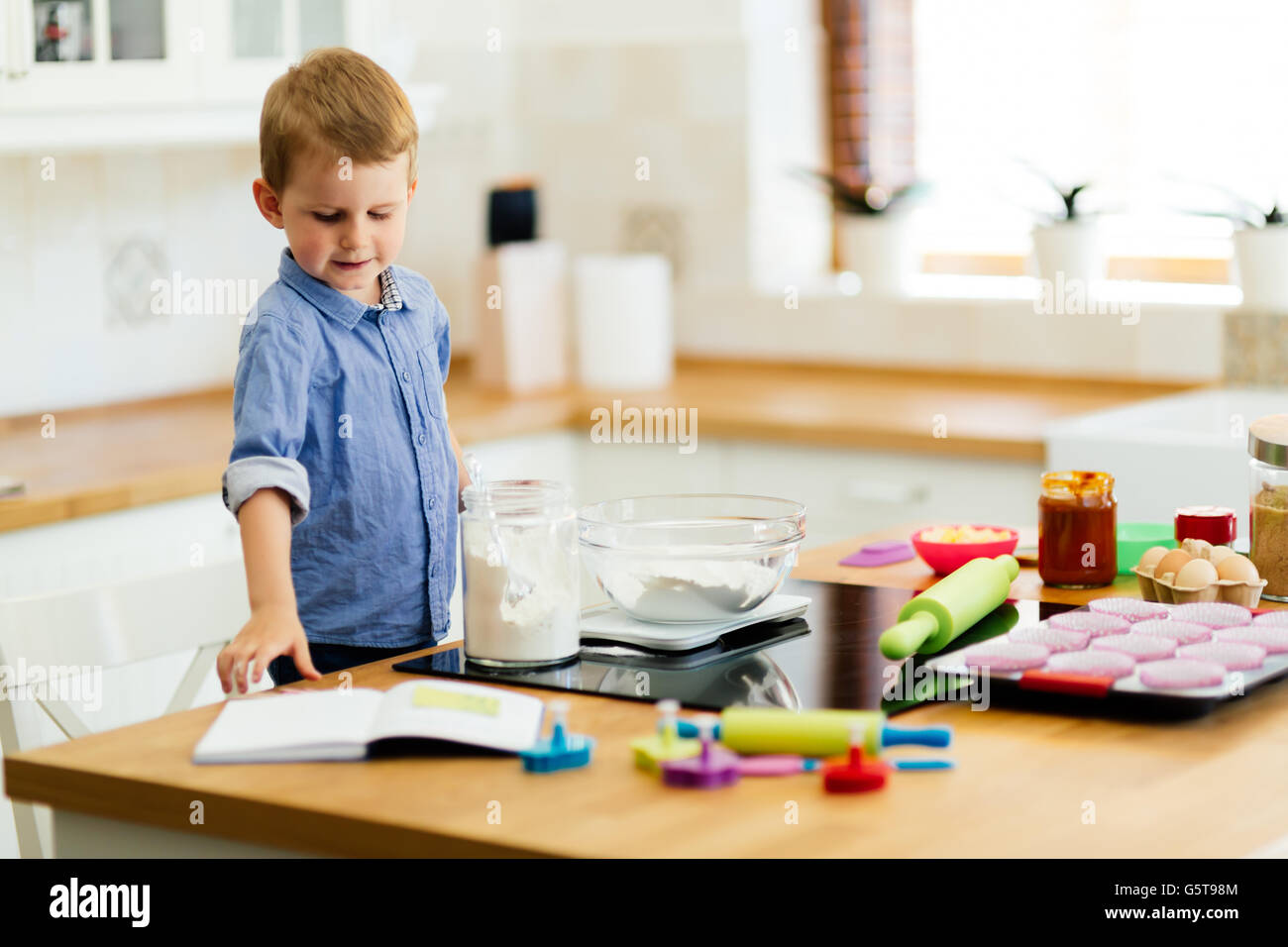Cute child learning to become a chef since the age of 2 Stock Photo - Alamy