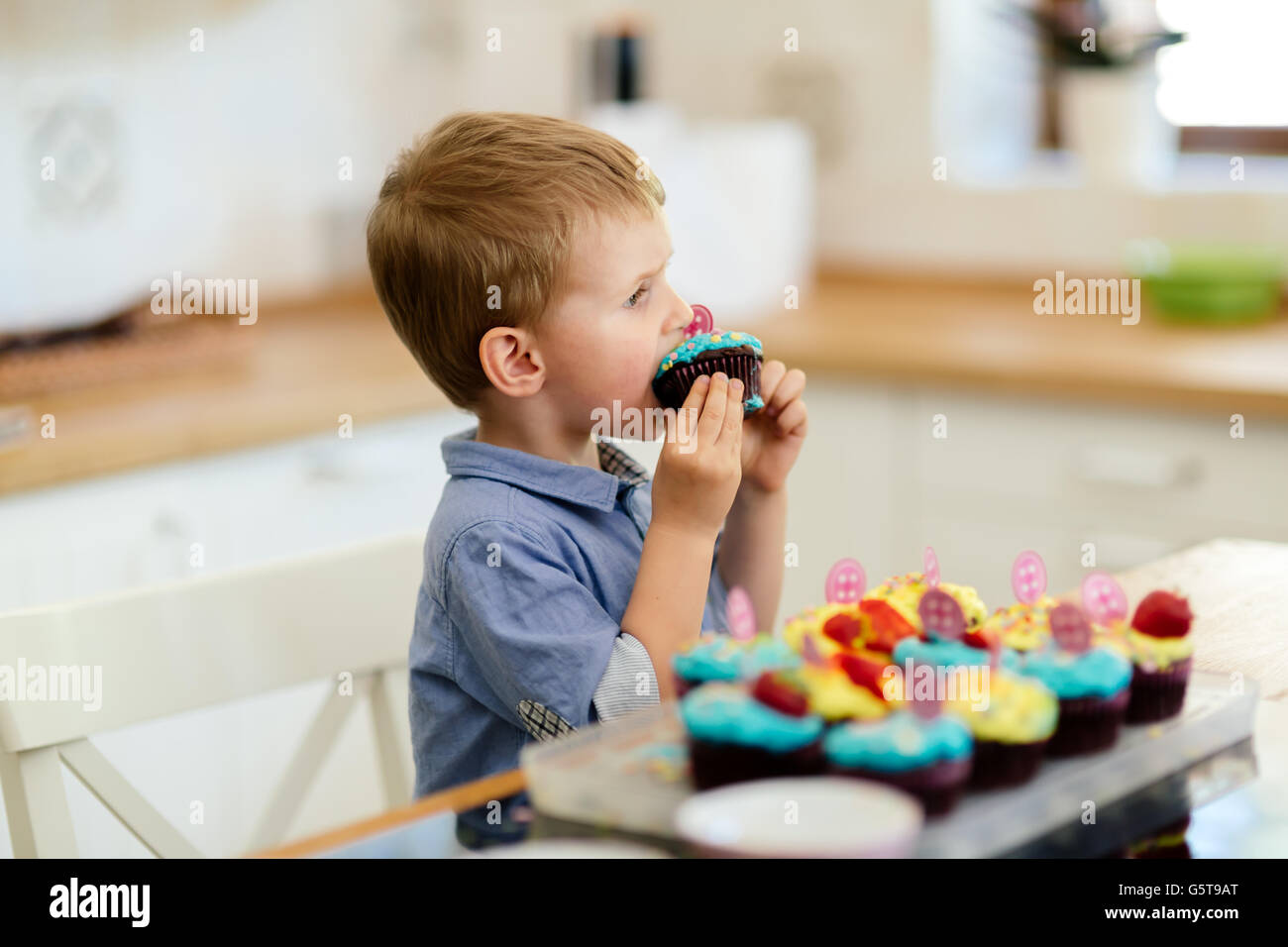 Cute child tasting cookies in kitchen Stock Photo - Alamy