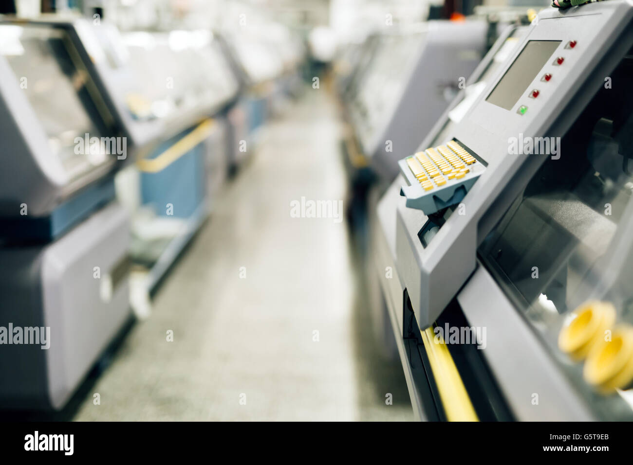 Computerized knitting machines in textile factory Stock Photo - Alamy
