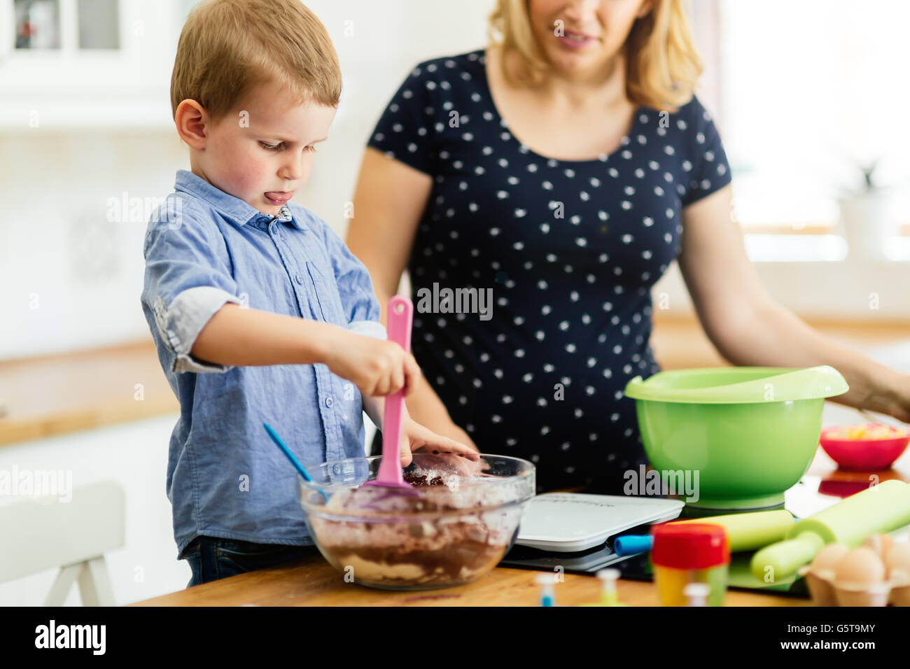 Beautiful child and mother baking in kitchen with love Stock Photo - Alamy